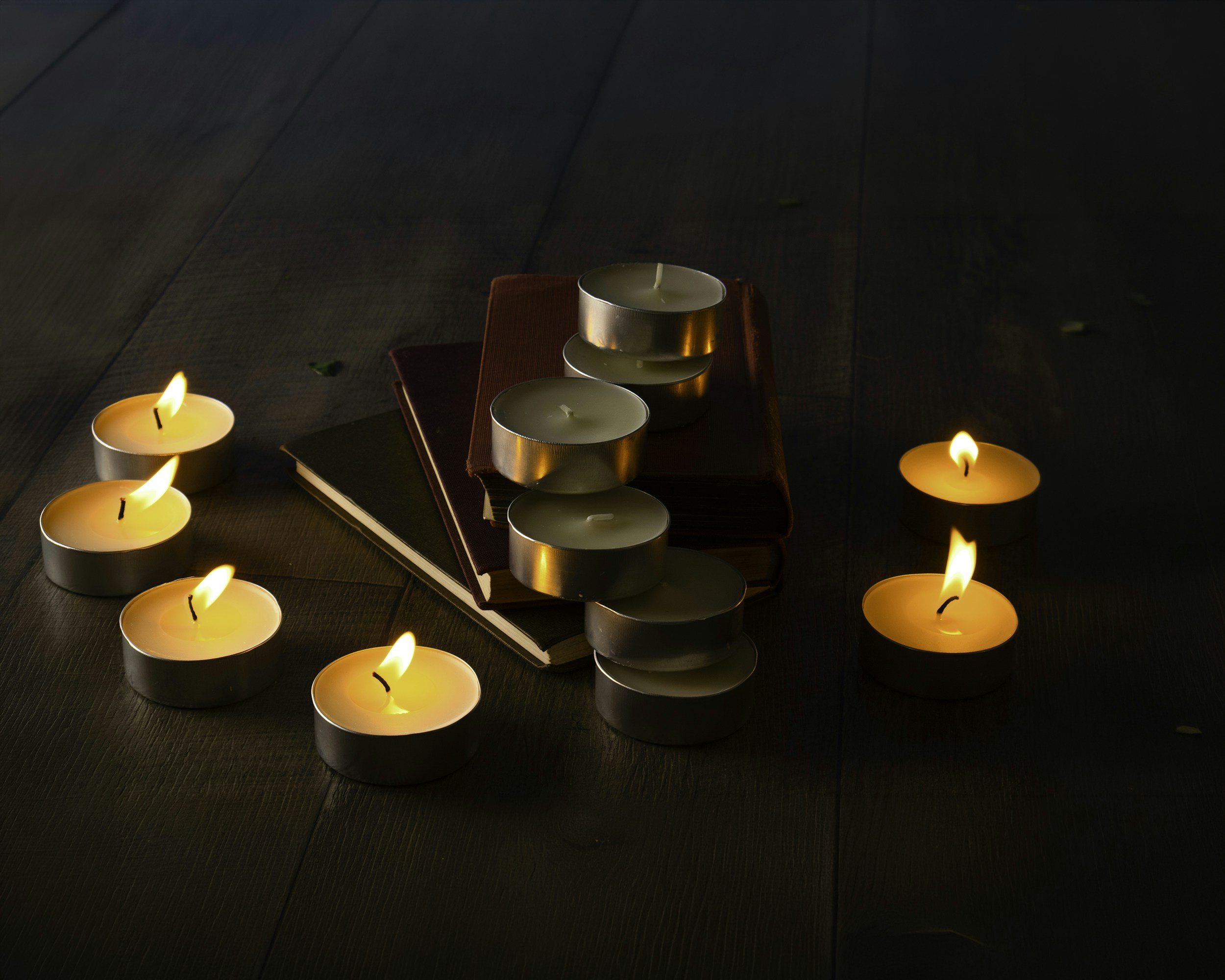 Candle-Rhythm: A Quiet Still Life with Stacked Tealights and a Folded Book