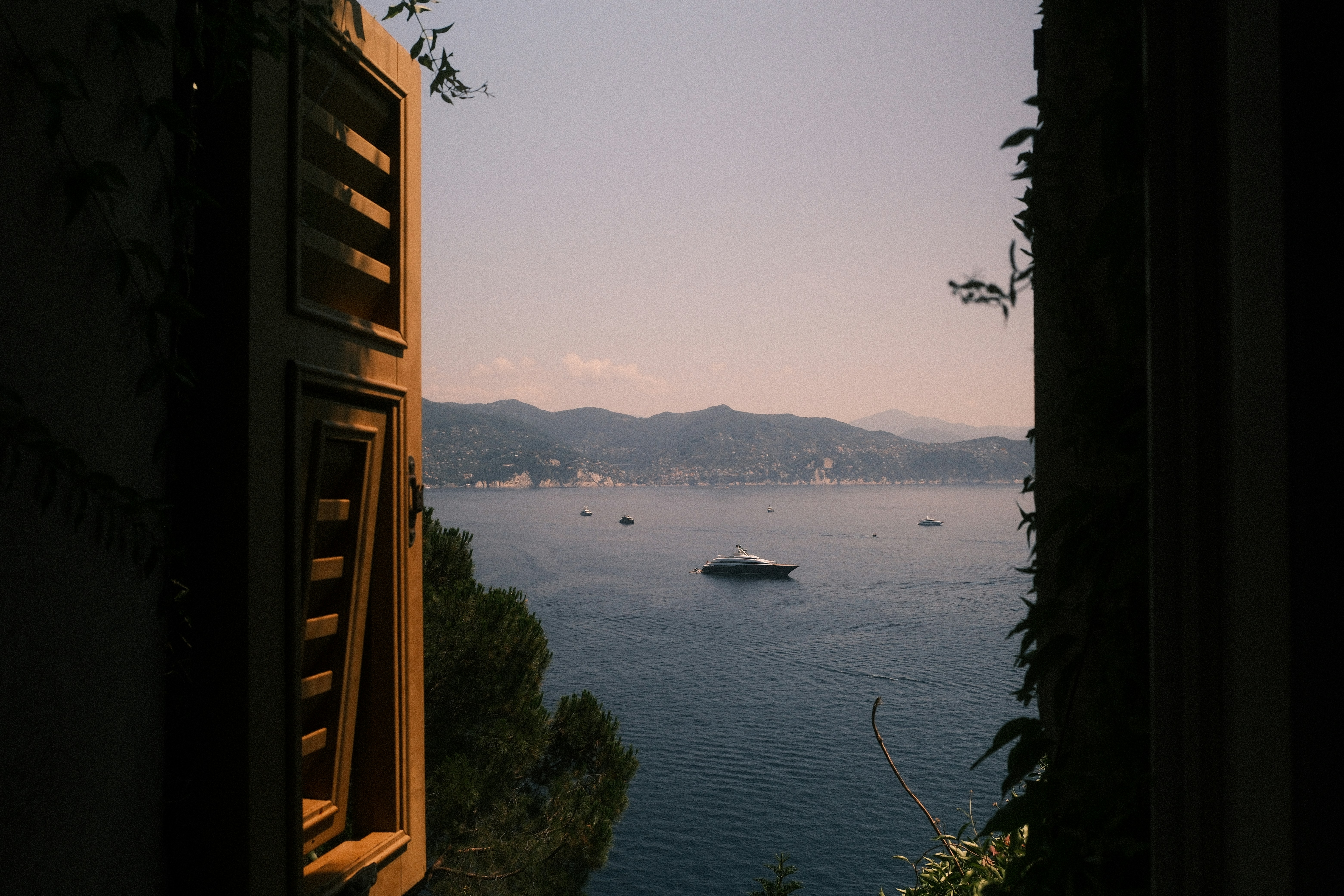 Doorway to the Lake: Framed View Through an Ivy-Clad Arch