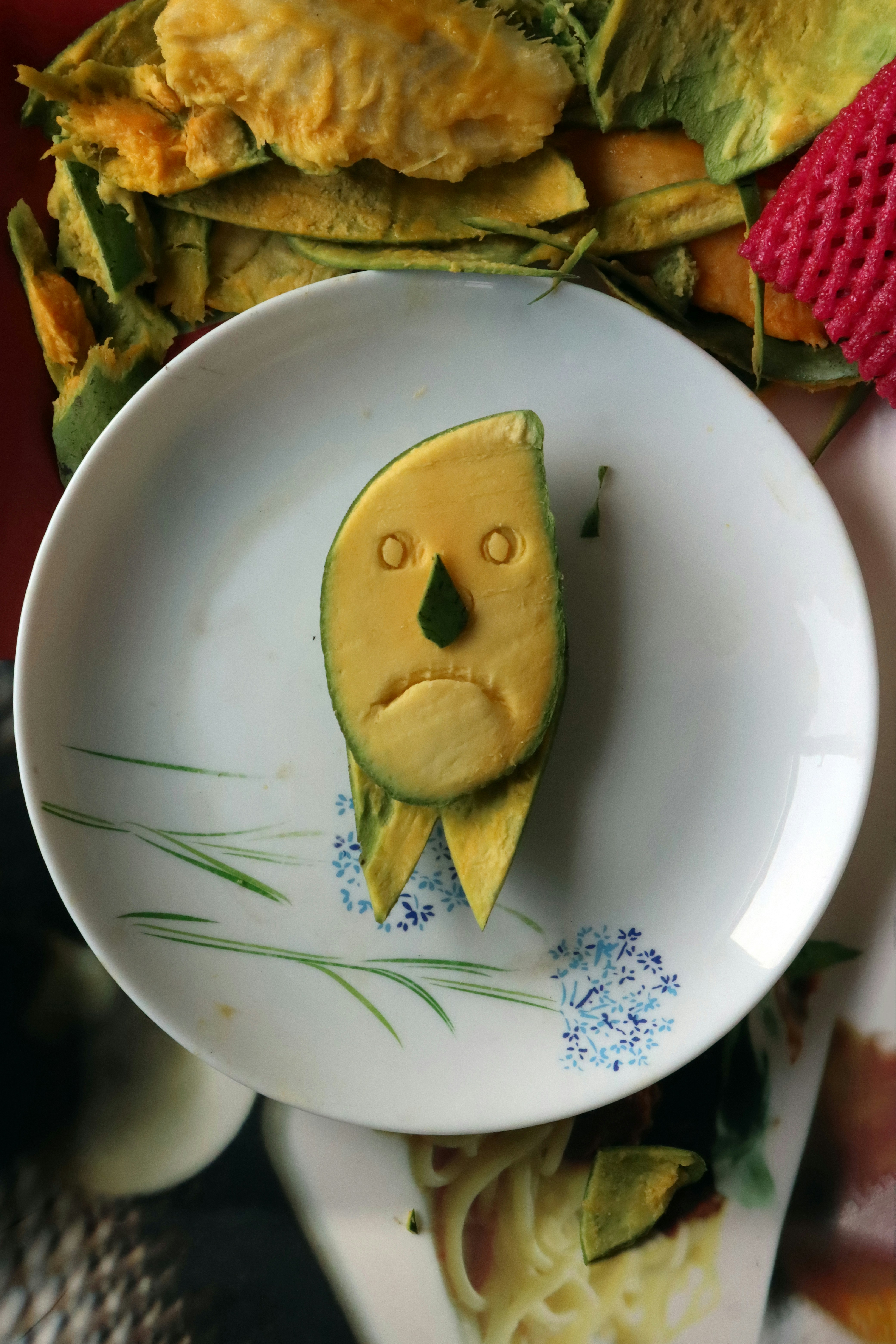 Melancholy Avocado Figurine on a Plate of Garden Fritters