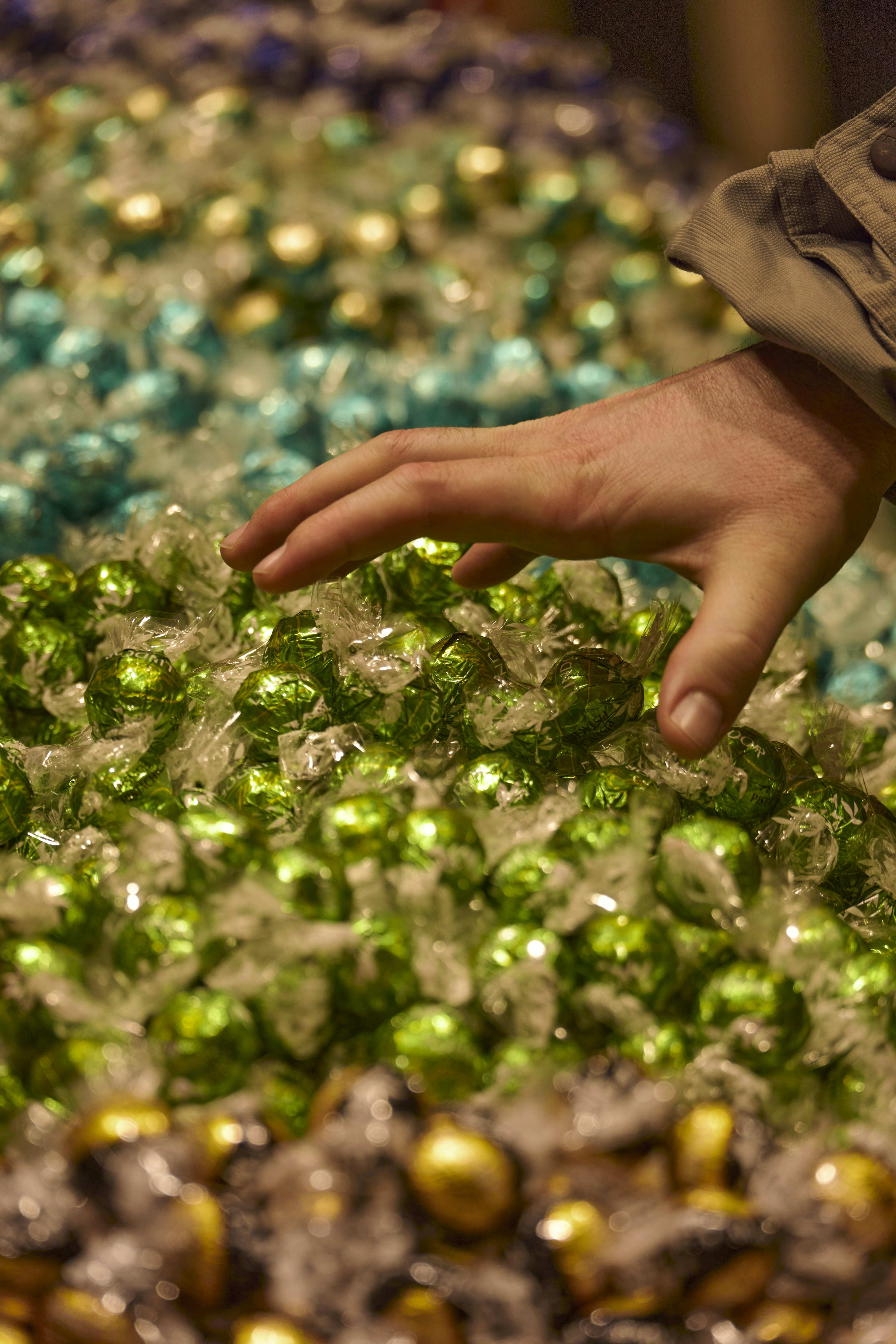 Candy Hands: A Gentle Touch Across Emerald Wrappings