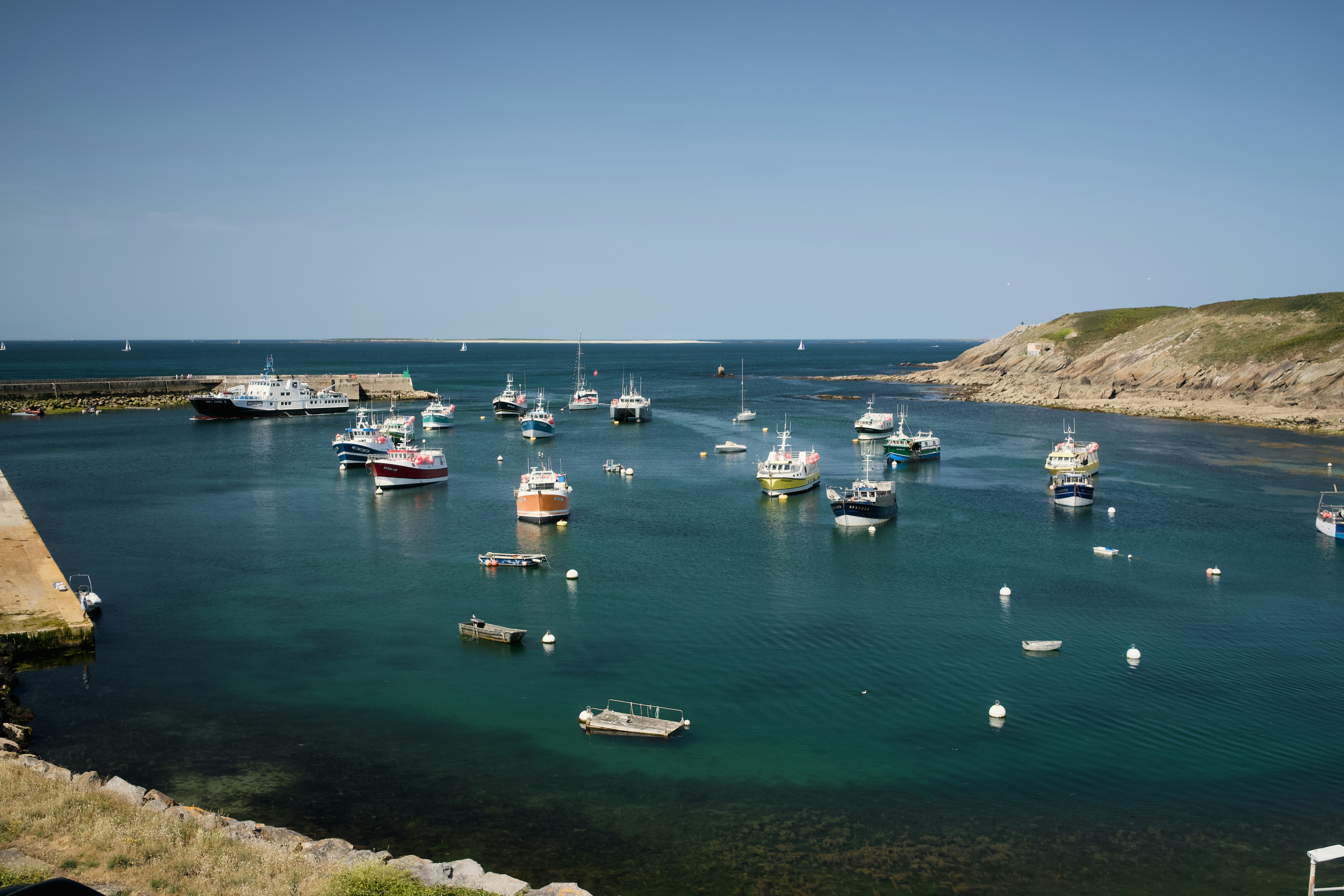 Harbor of Quiet Blue: Boats Anchored in a Coastal Cove