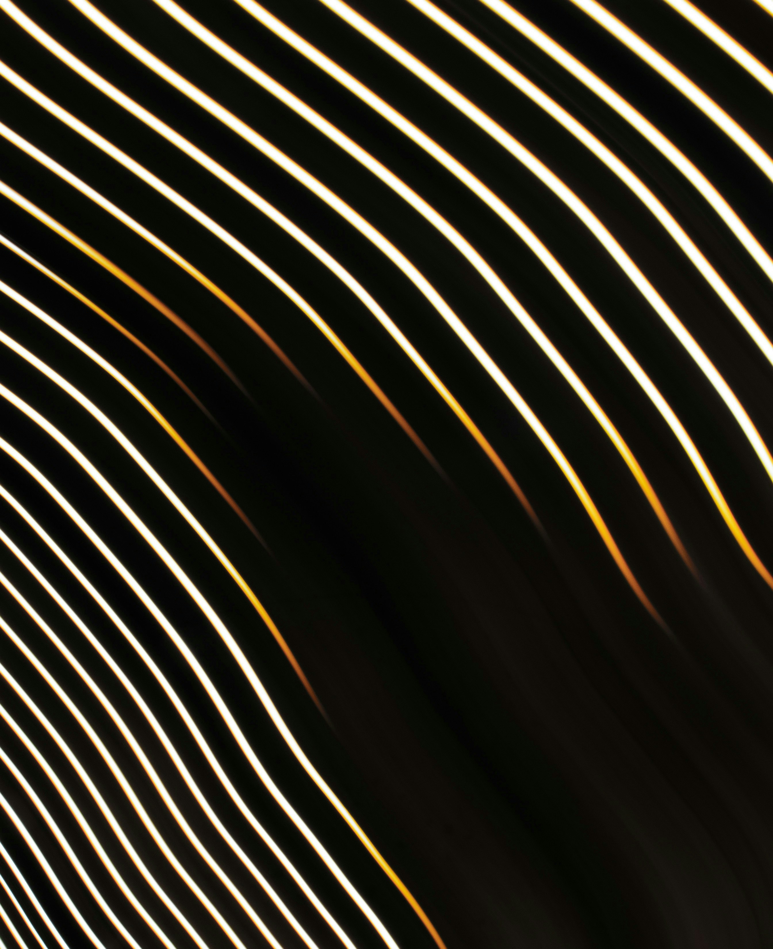 Light streaks against a dark background, suitable for a wallpaper.