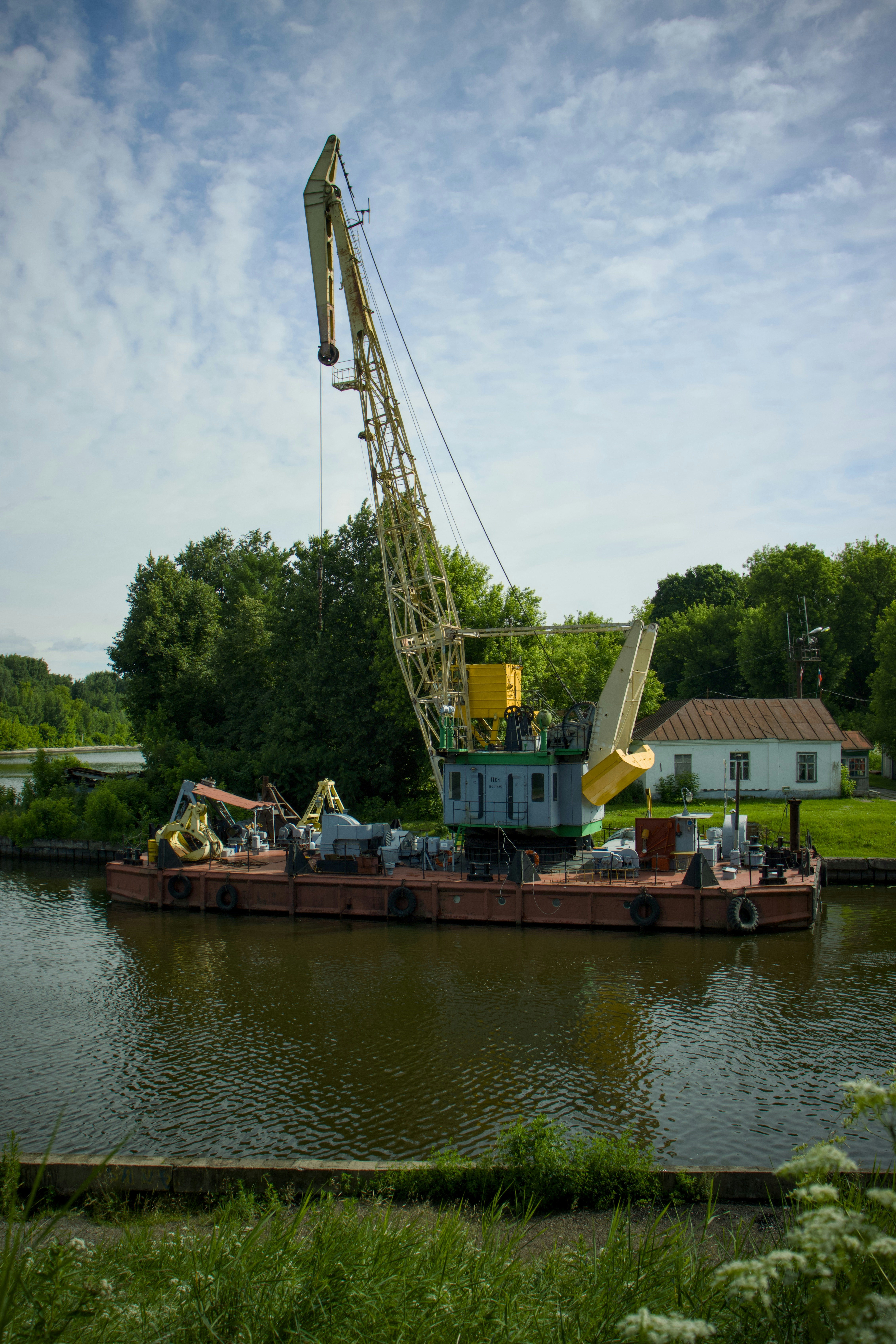 Floating Giant: A dredging crane anchors a riverside workday