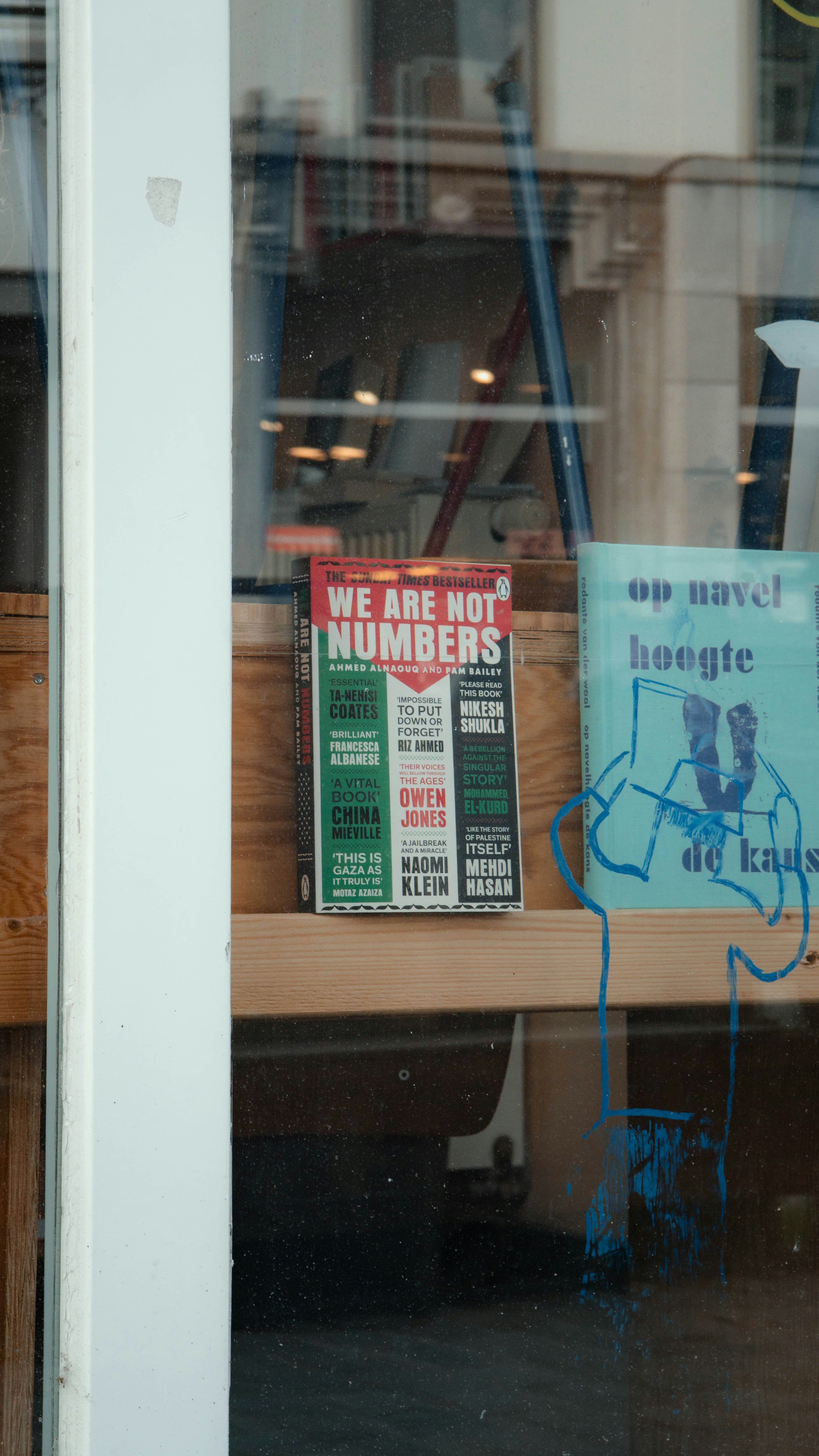 Streetfront Poster Still Life: A Book Display Through a Café Window
