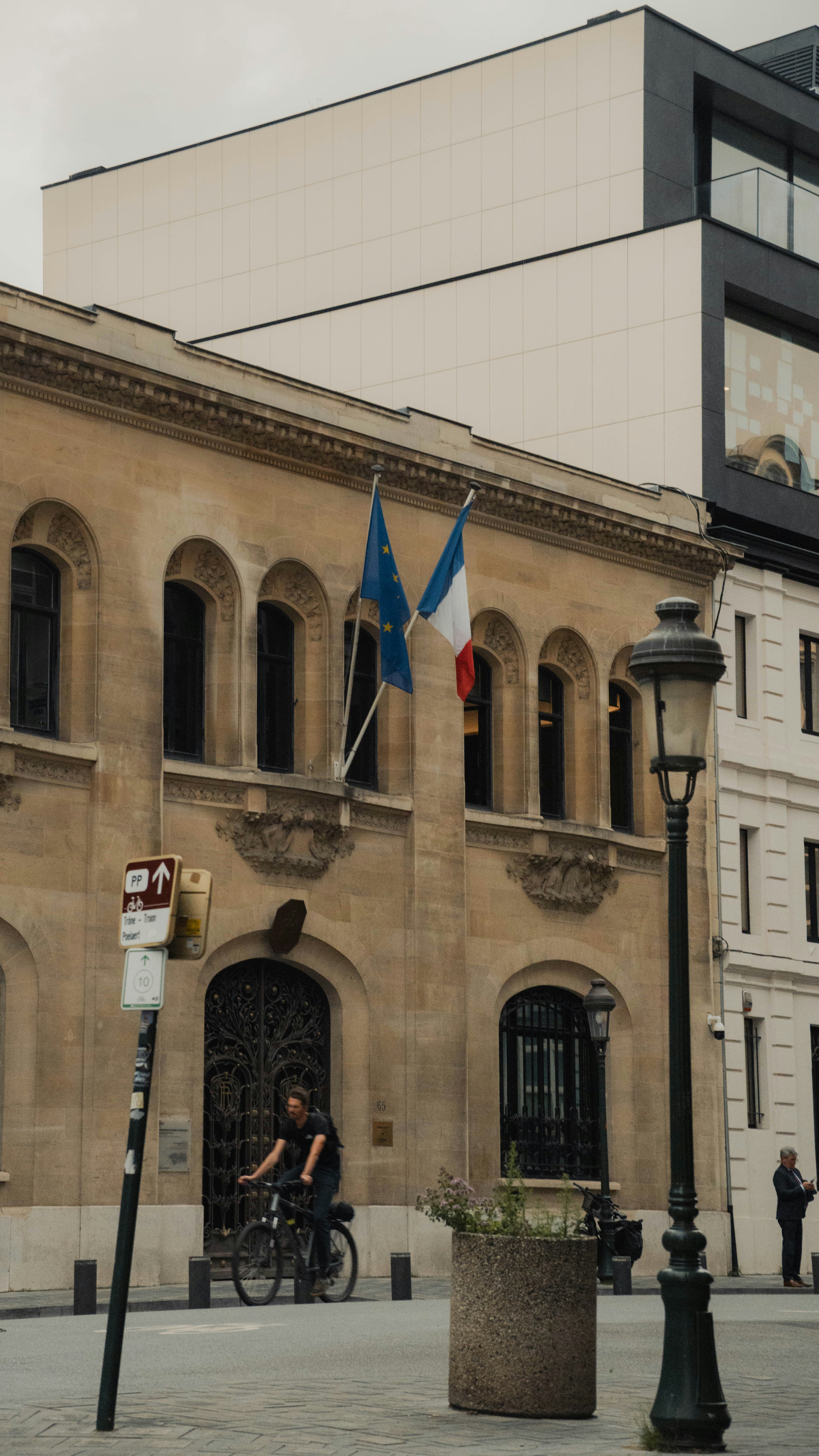Flag Banners over Classic Facade: City Street in Soft Evening Light