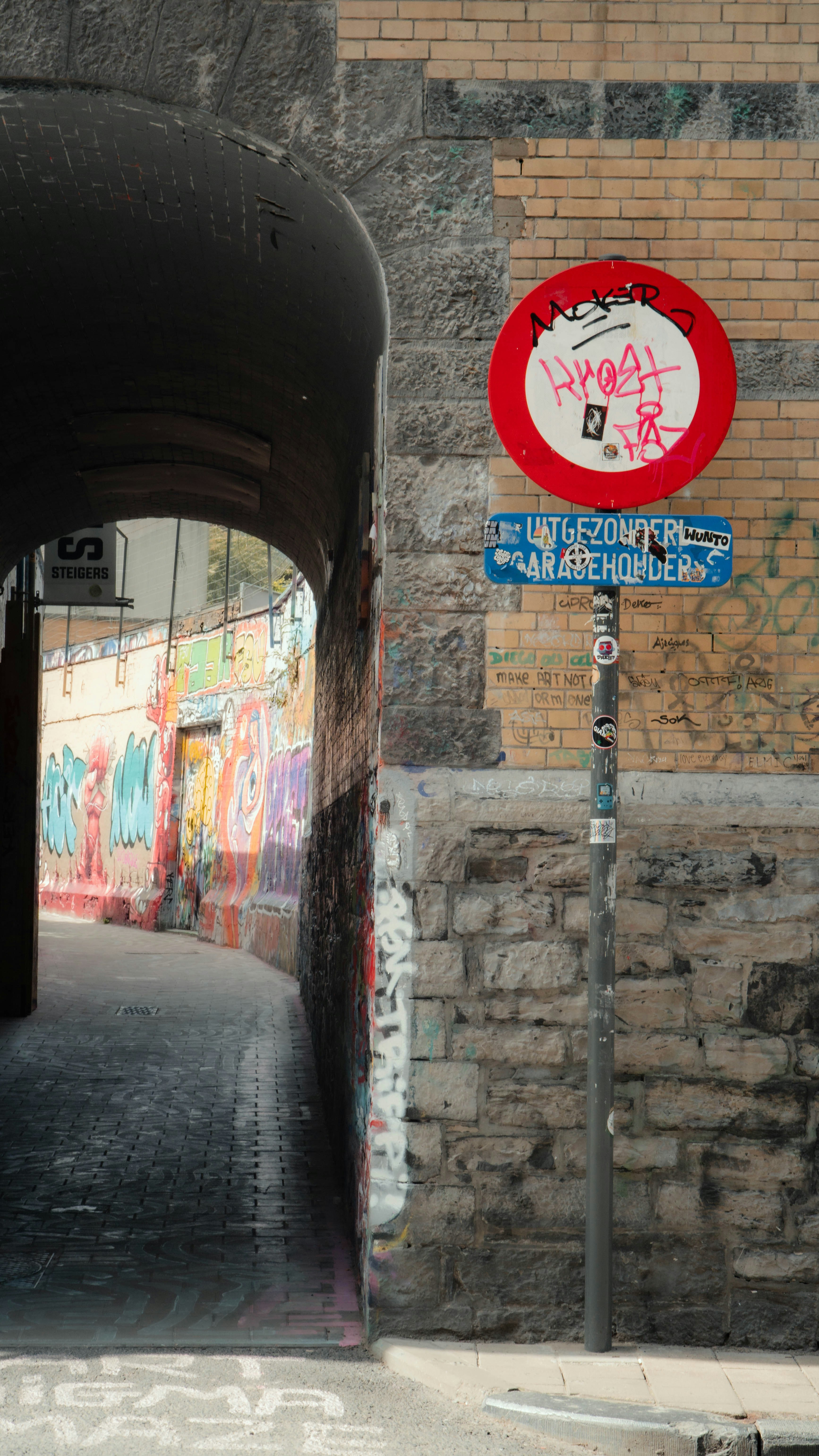 Graffiti Archway and Red-No Entry Sign: Urban Passageway