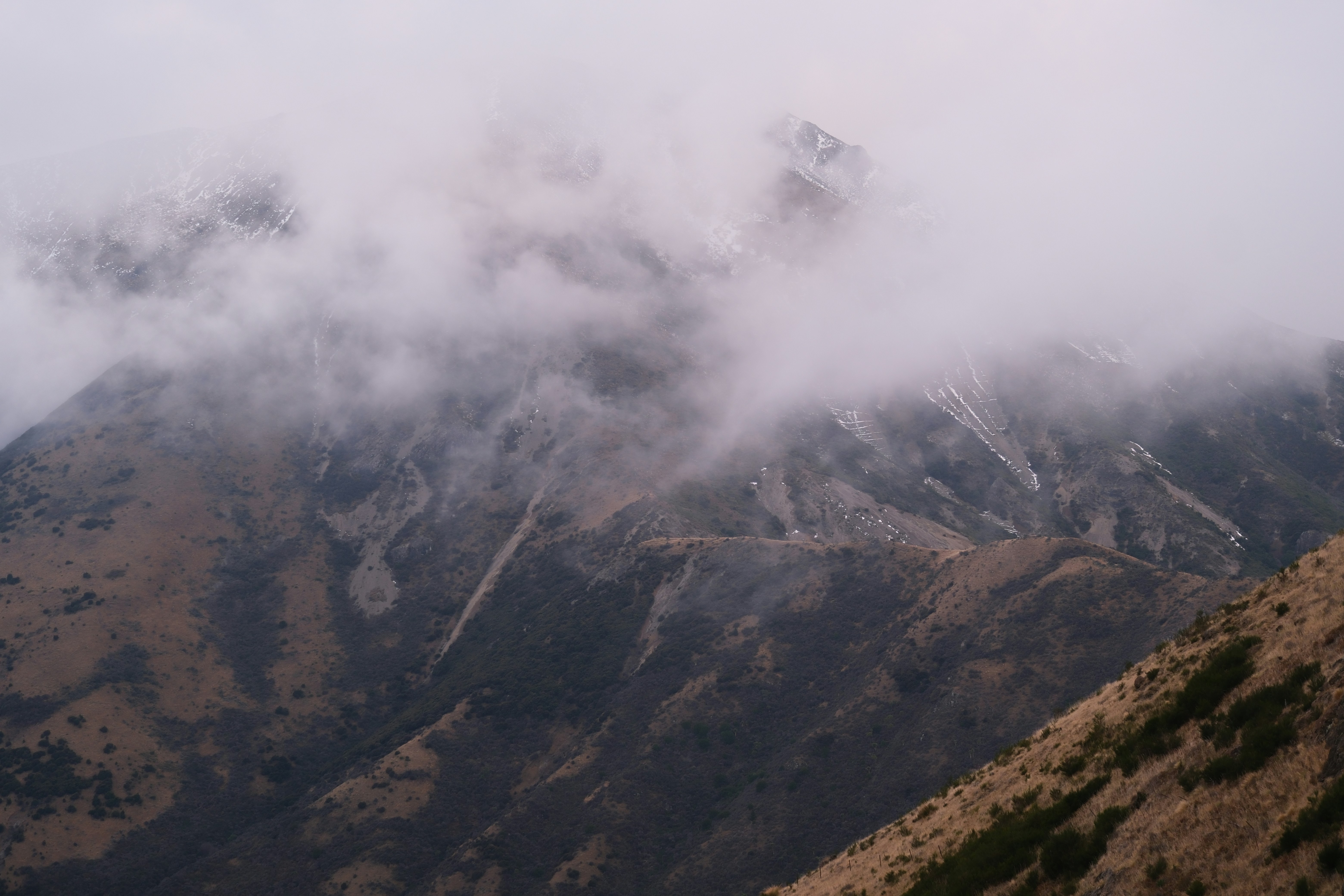 Mist-veiled Ridge: A Mountain Pass Through Low Clouds