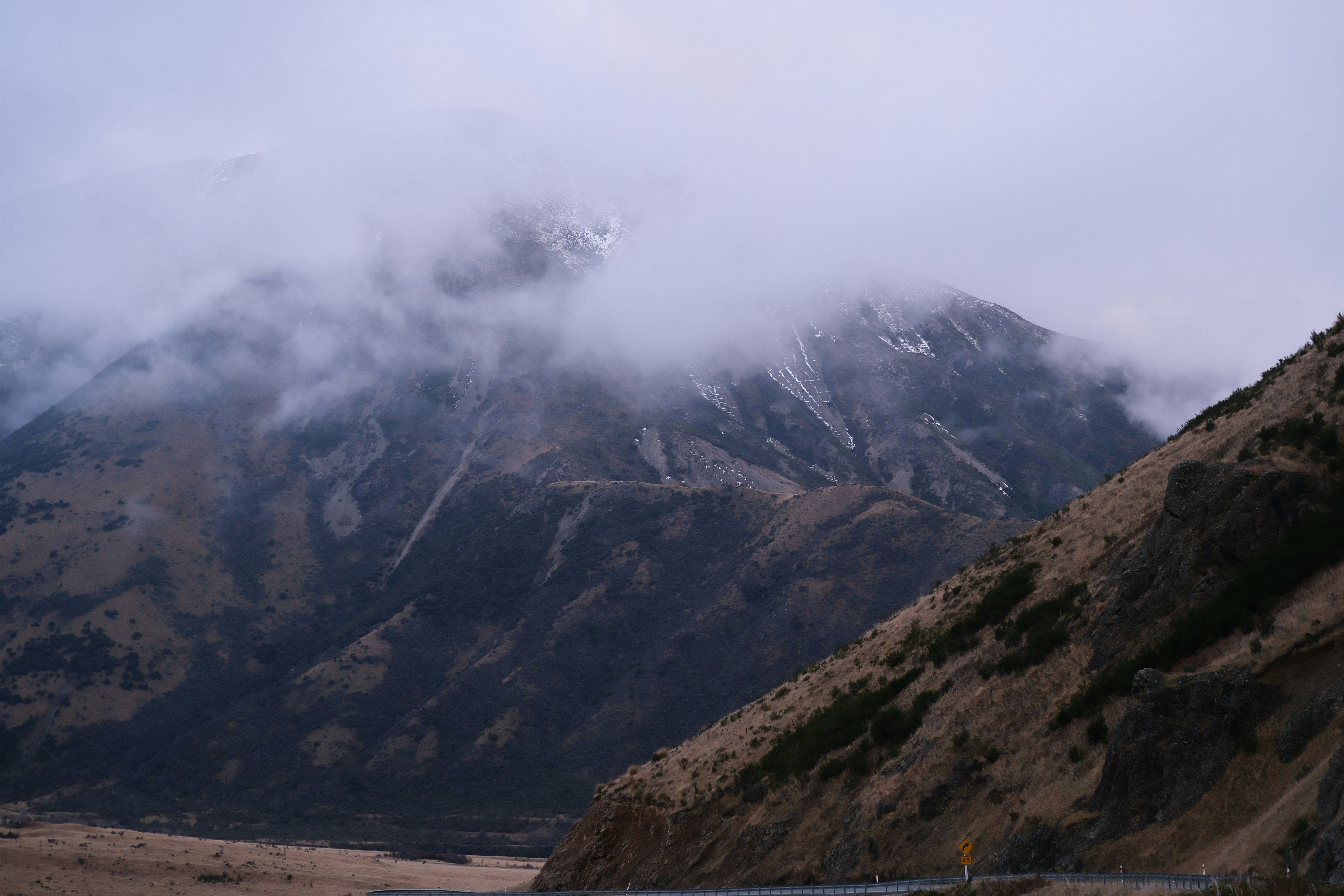 Clouds Cling to Summit: Mist veils the rugged range