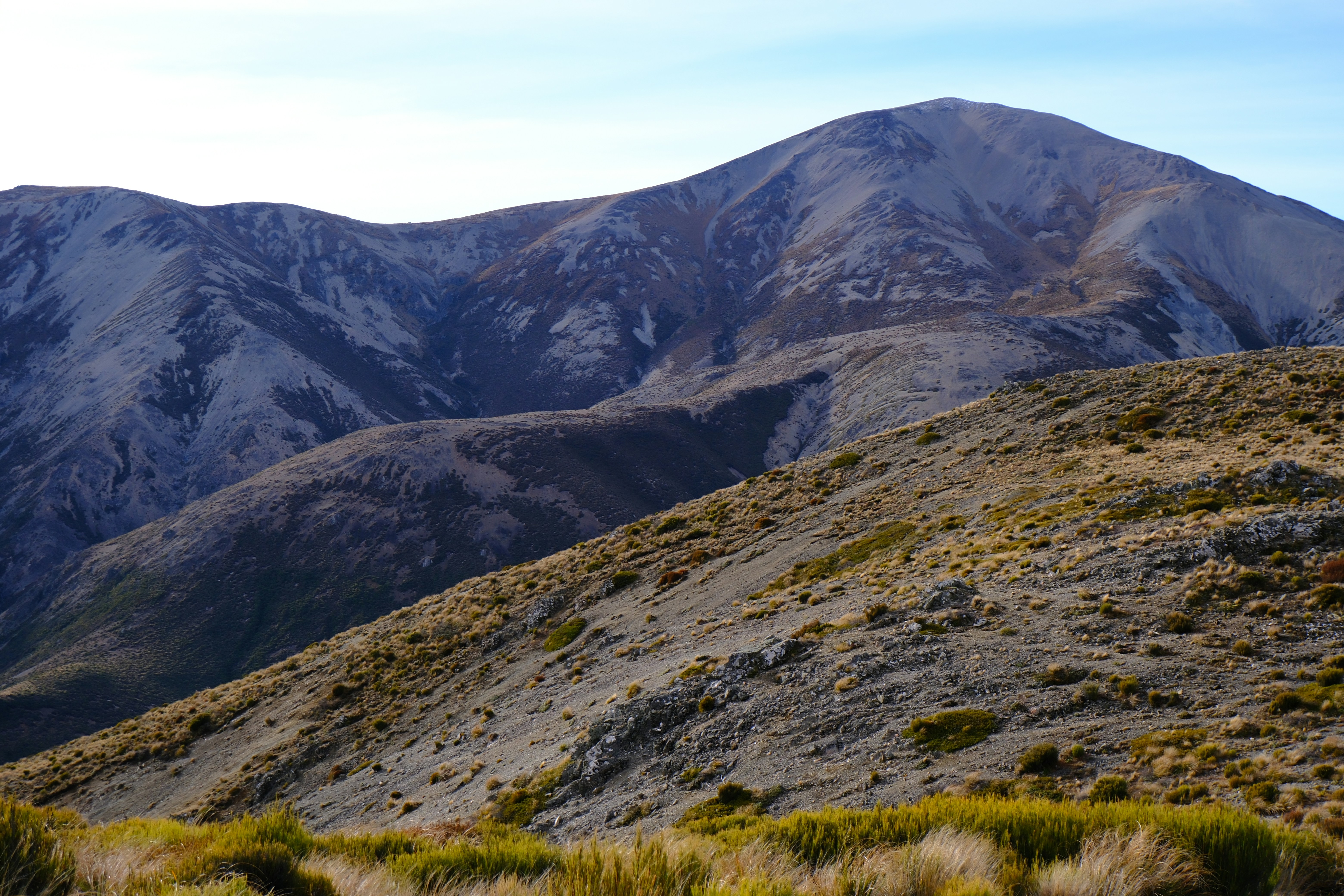 Snow-dusted ridge beneath a sunlit peak
