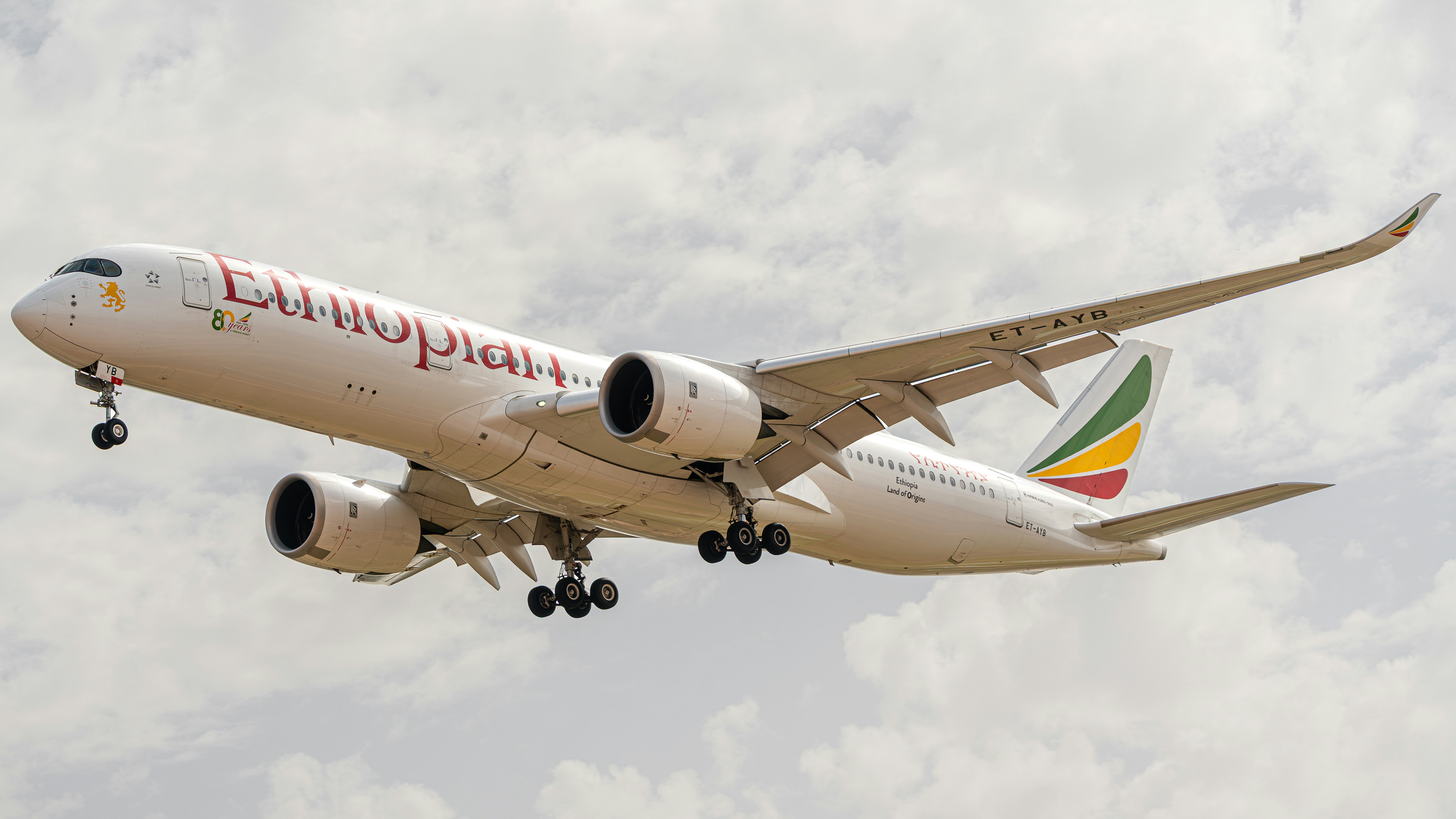 A forward‑facing jumbo in ascent under a puffy sky