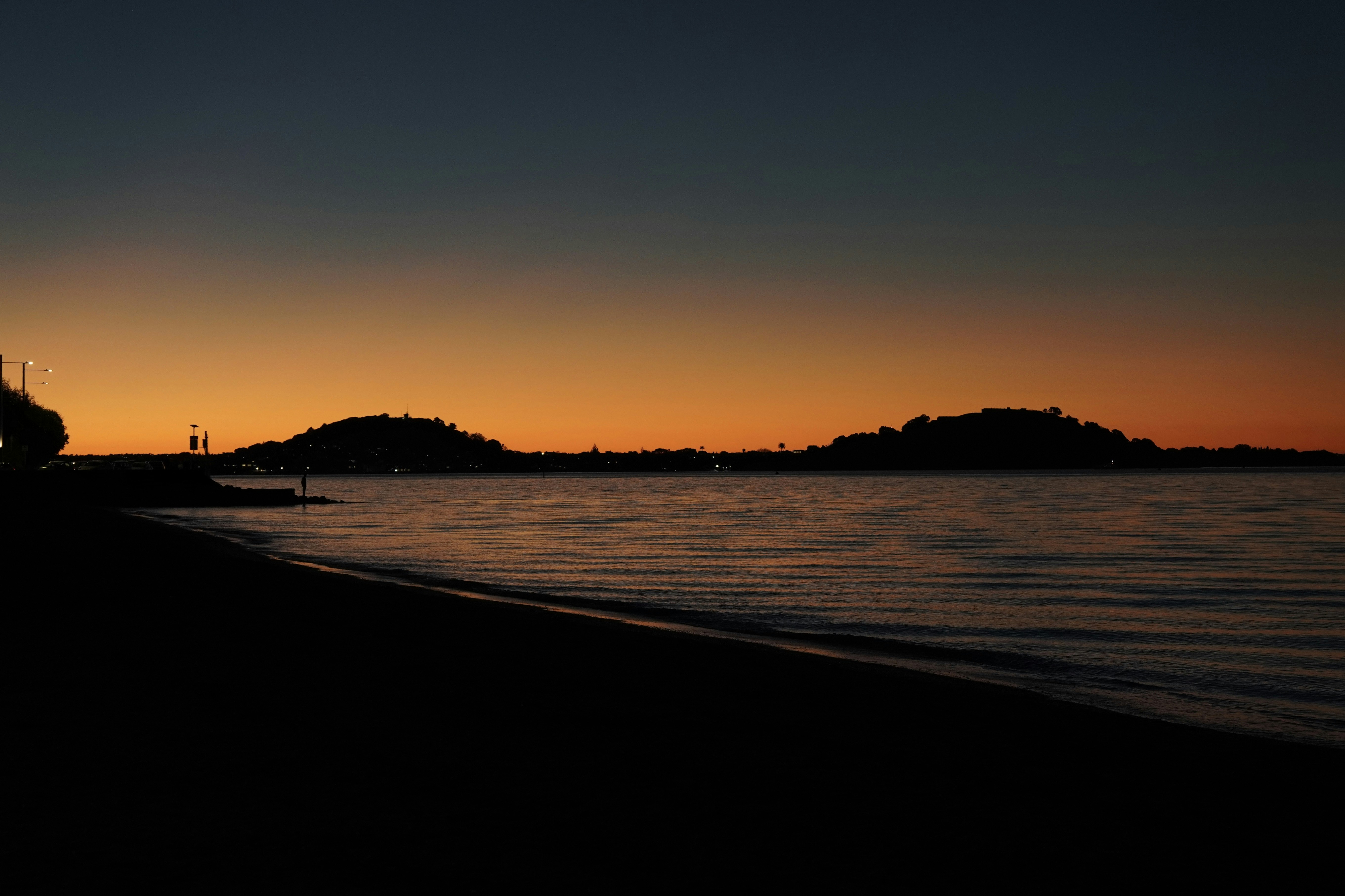 Horizon Glow over a Quiet Bay at Dusk