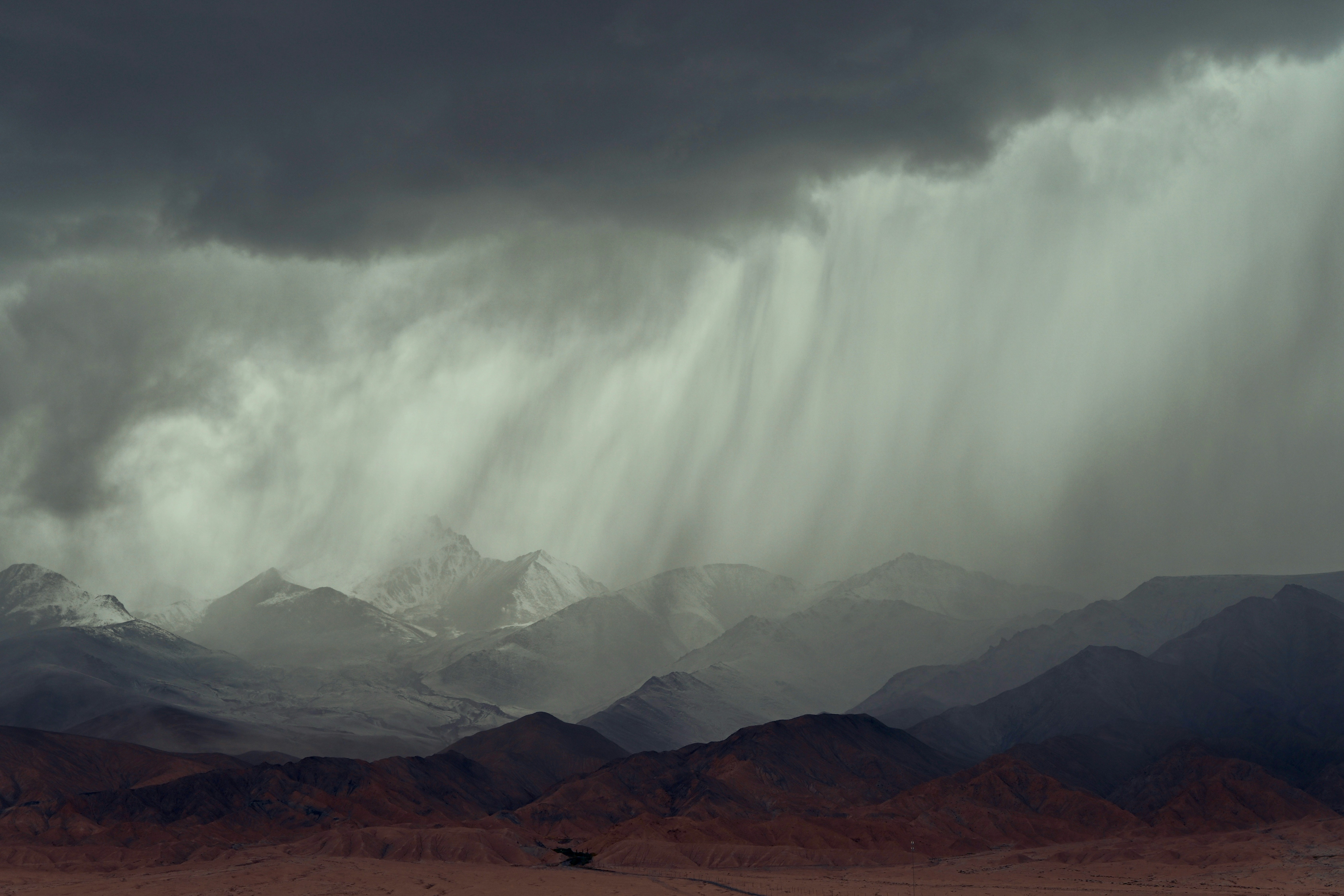 Storm-Drawn Peaks Beyond a Quiet Desert
