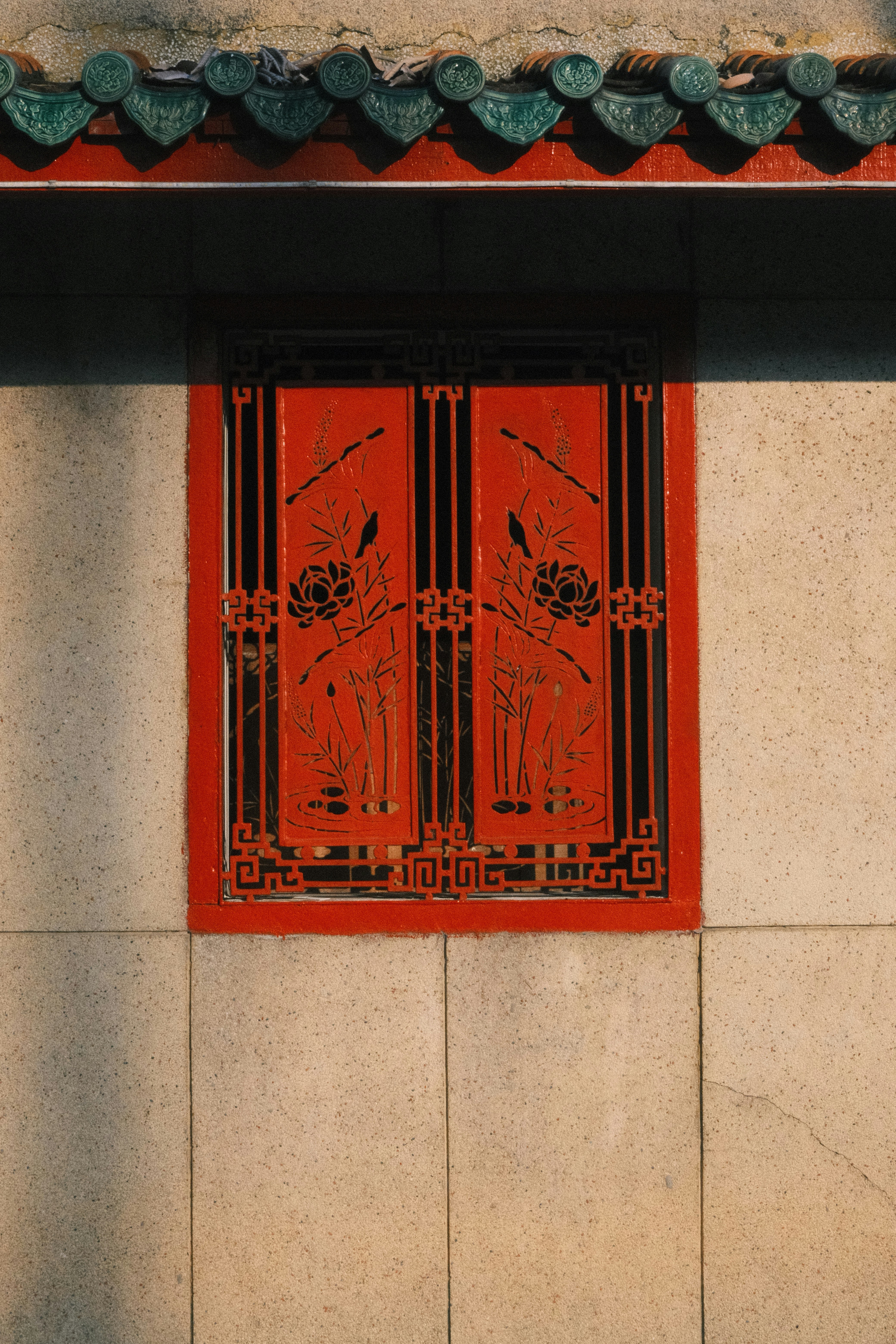 Red Gate in Stone: An Ornamental Doorway Framed by Quiet Wall