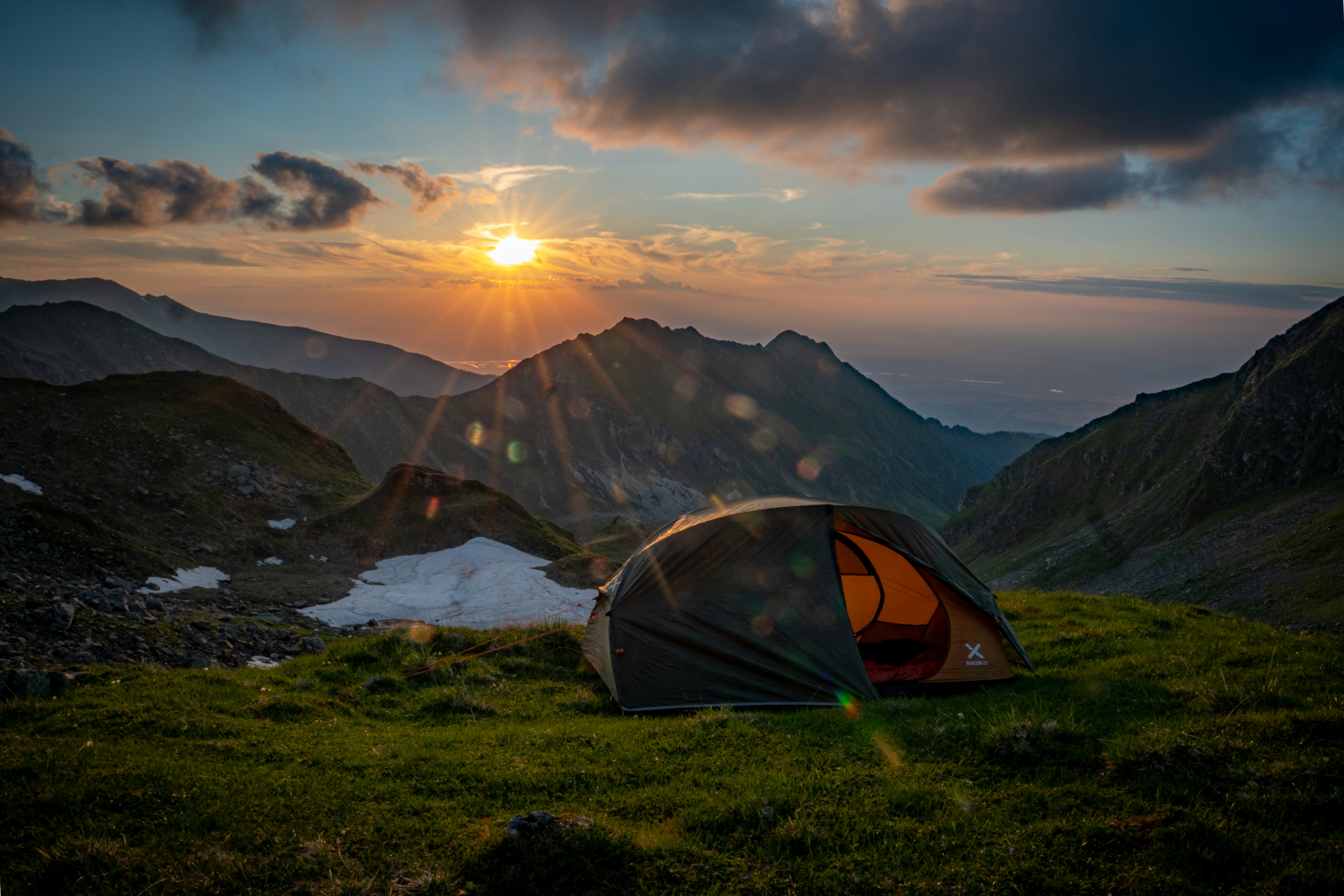 A tent set up in a mountain landscape at sunset. photo – Free Sunset ...