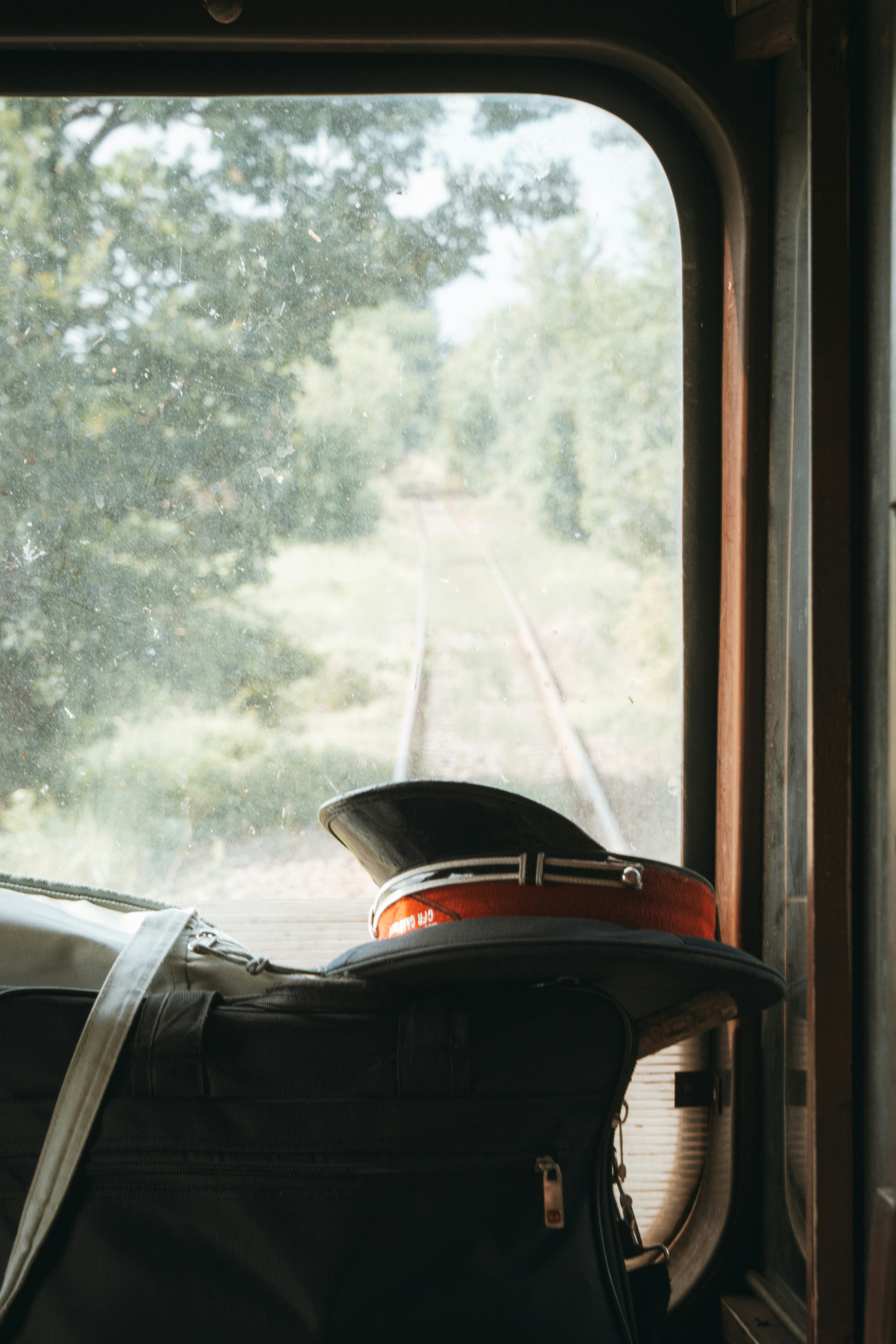 Remembering the Rails: A Captain's Cap resting by the Window