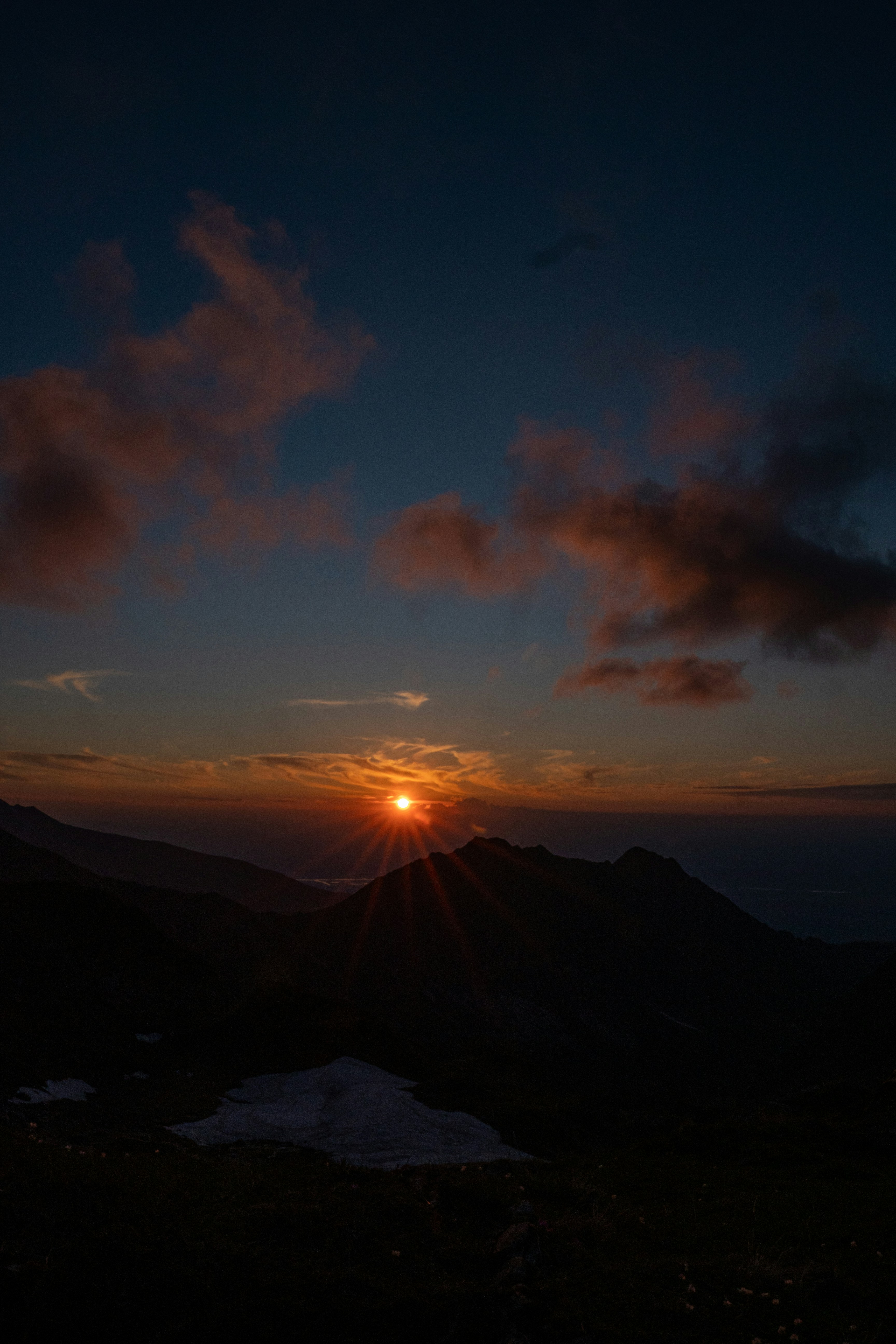 Sunrise Over Silhouette Peaks: A Quiet Descent into Night’s Edge