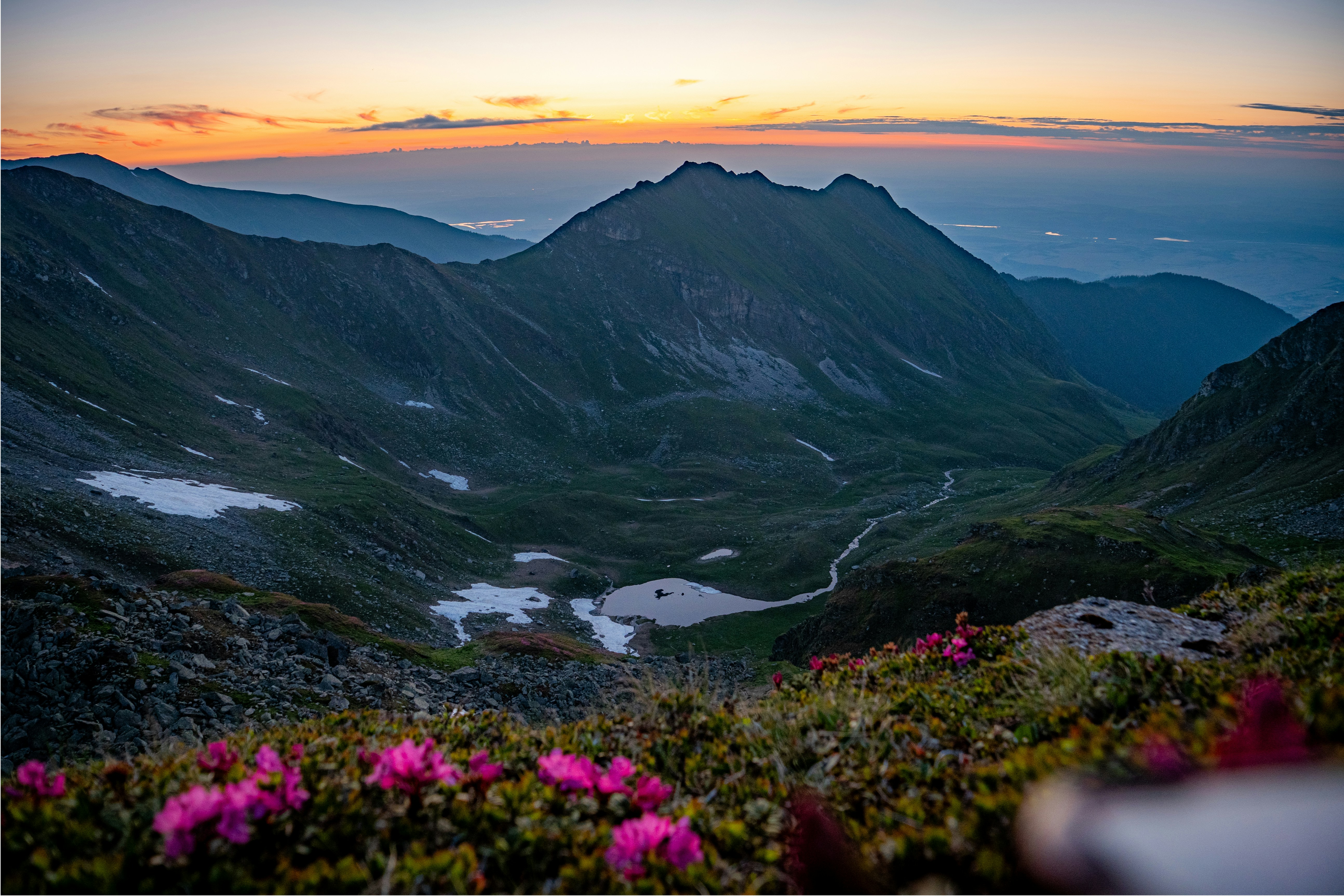 Dawn Ascend: Alpine Basin Beneath an Amber Sky