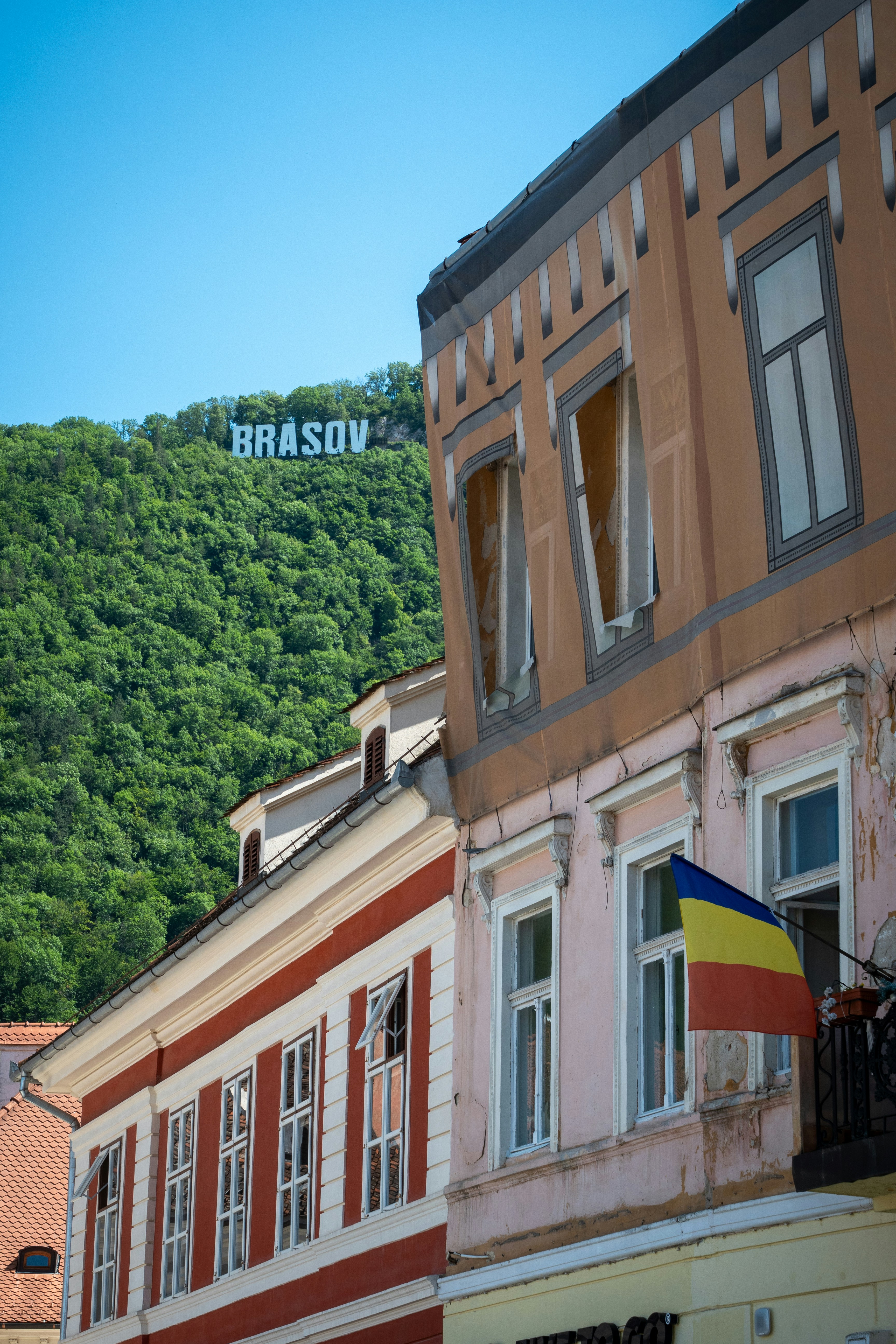 Brass Signage Over Hillside: Bratislava’s Balcony and Romanian Flag