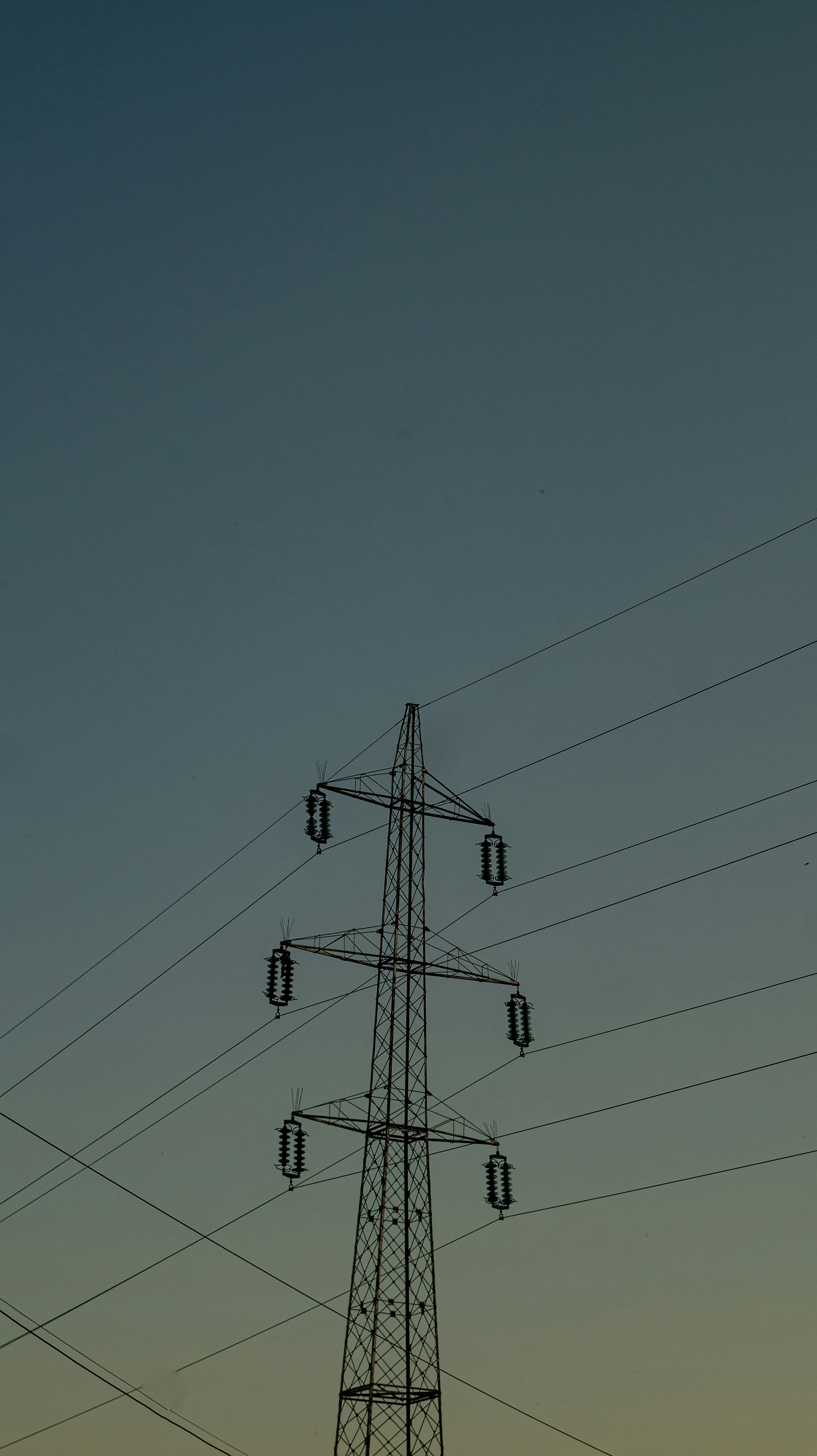 Midnight Toll: A Lone Transmission Tower Reaches Upward
