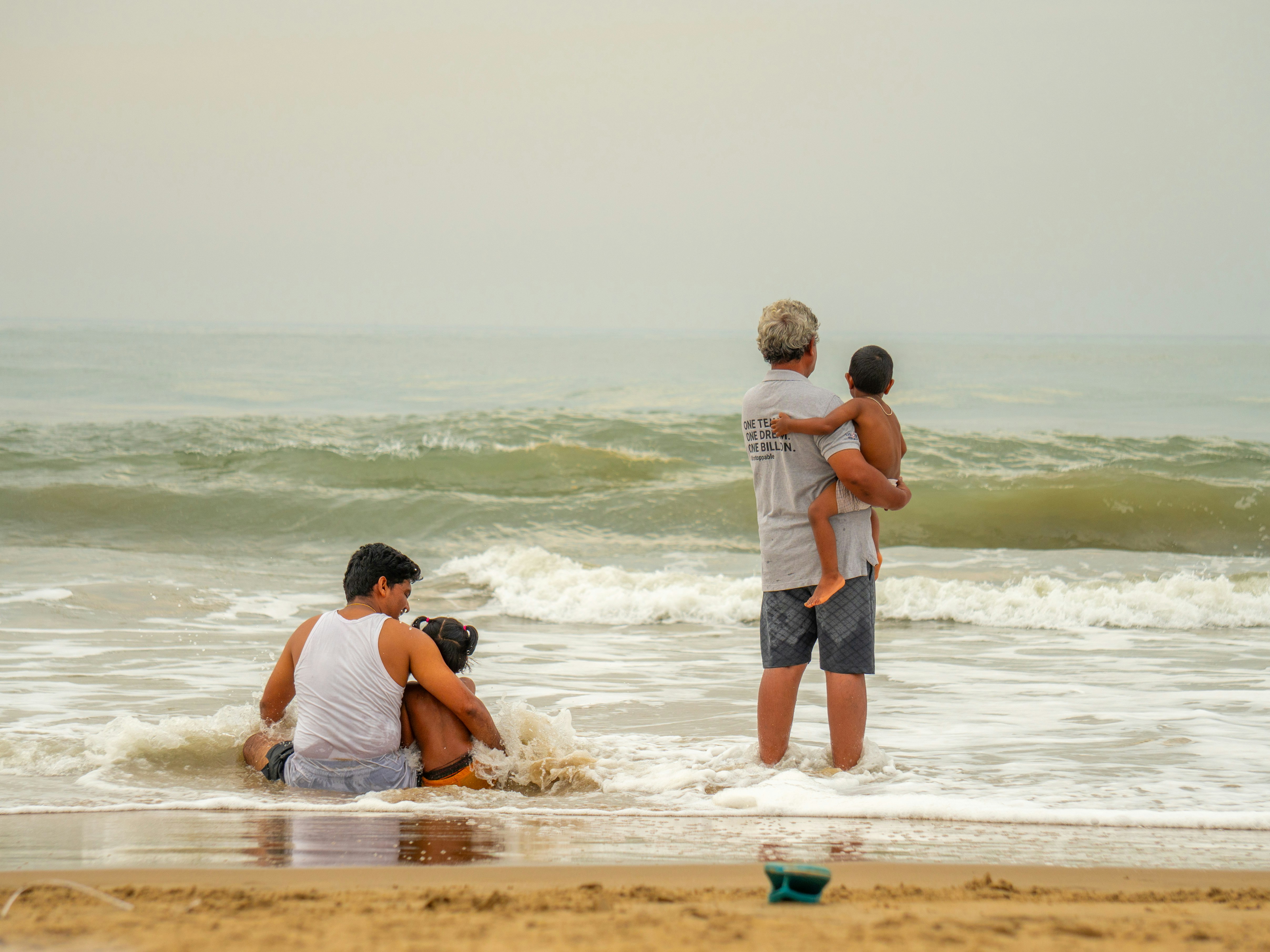 Family Moment at Shore: Embrace by the Tides