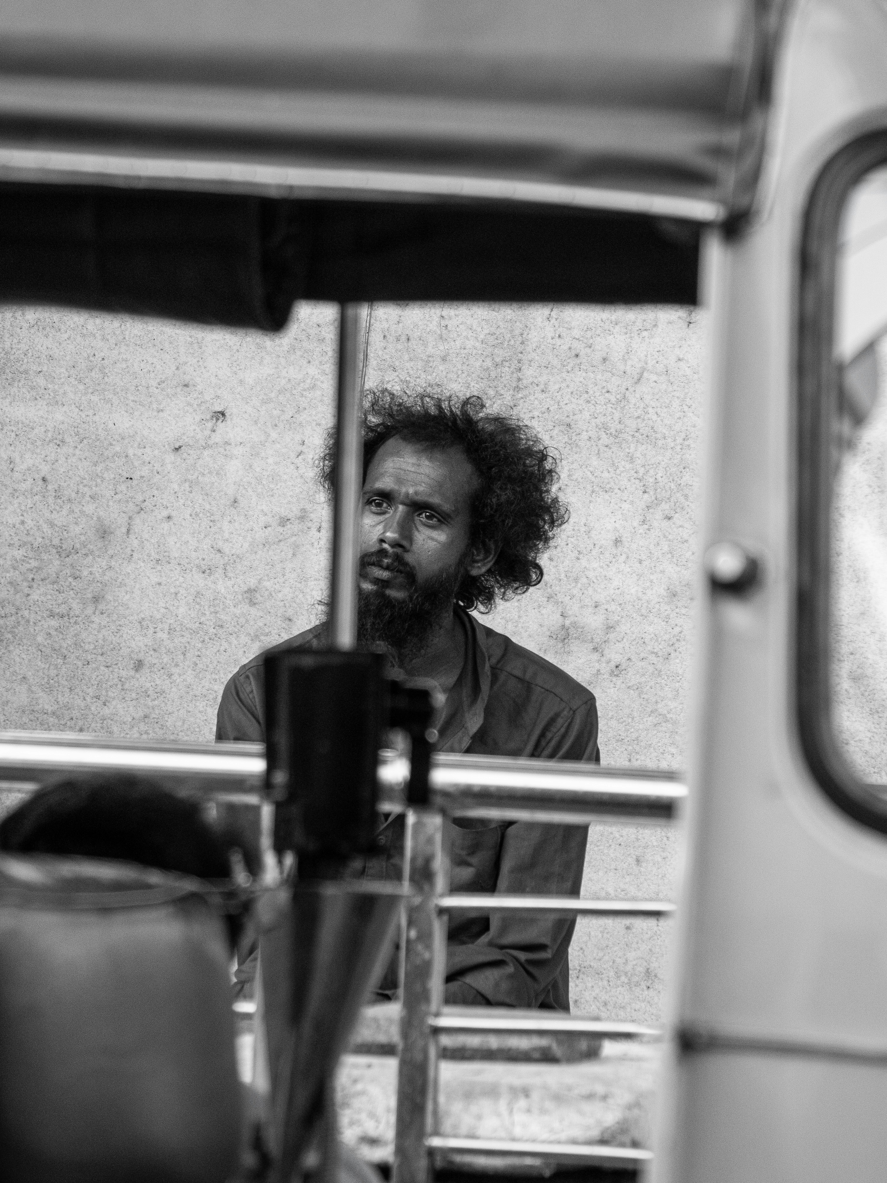 Eyes in the Shadowed Frame: Portrait Through a Machinery Gap