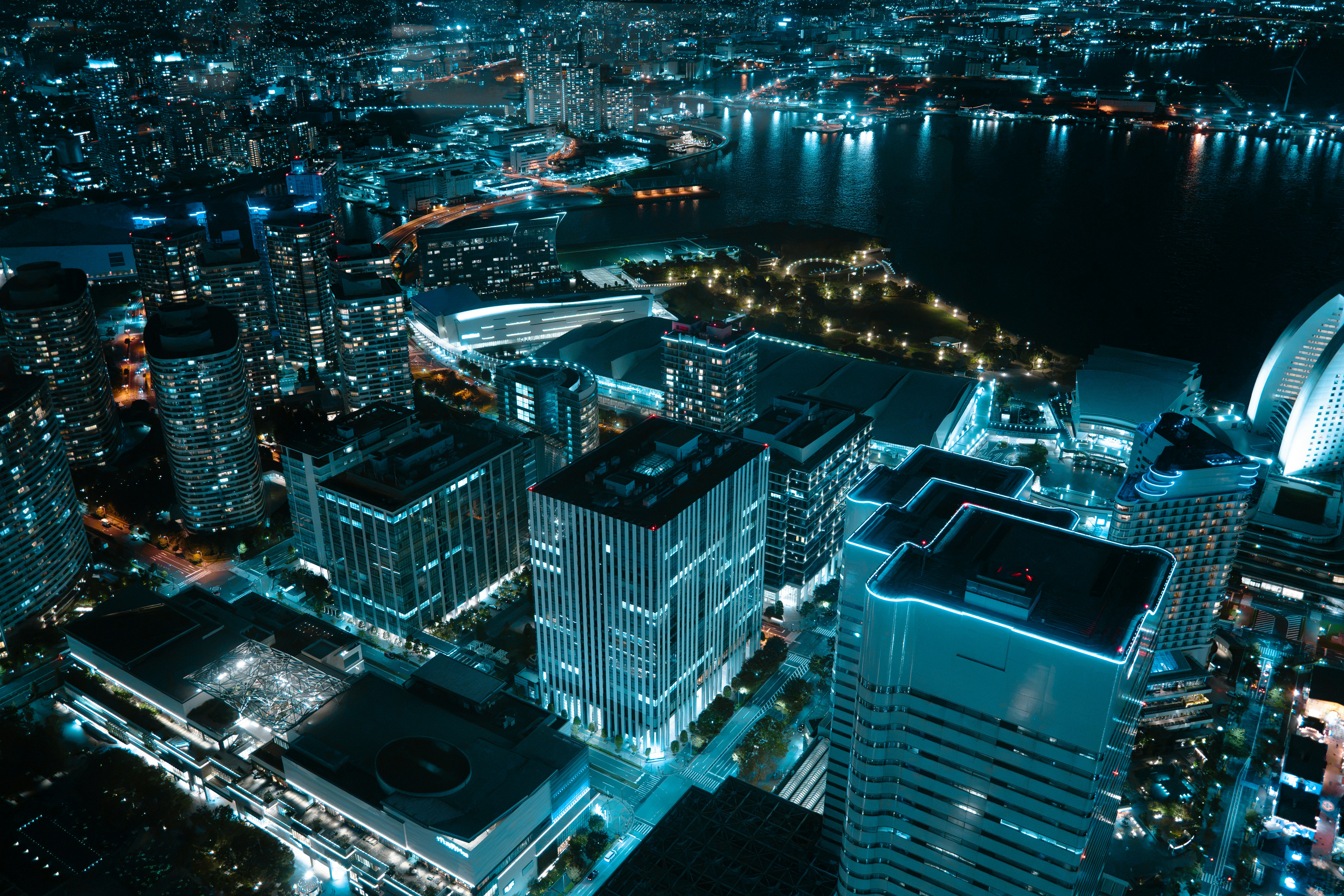 Neon Currents: A Bird’s-Eye Night Over a Glowing Marina City