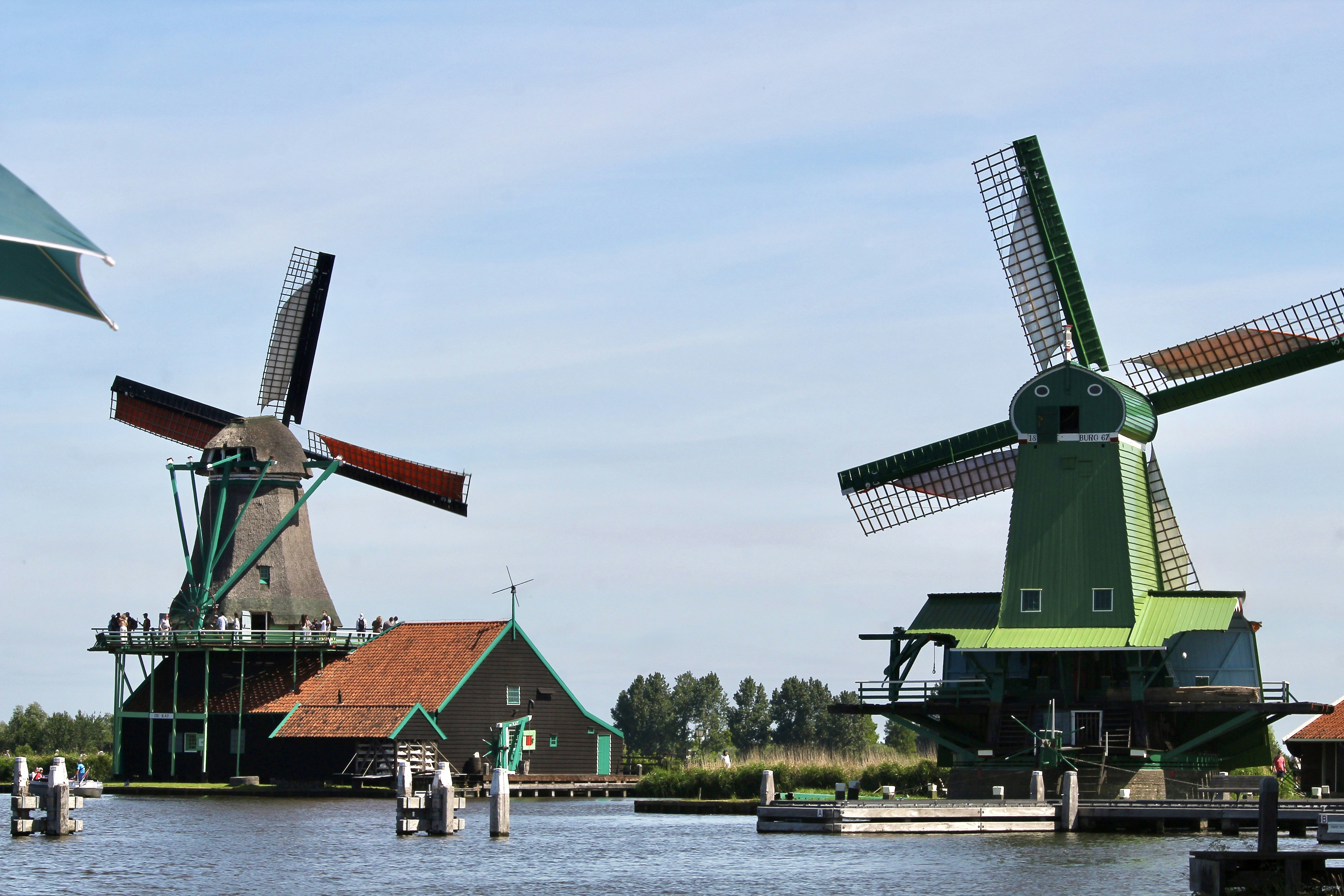 Two Dutch Windmills Rest on a Quiet Canal