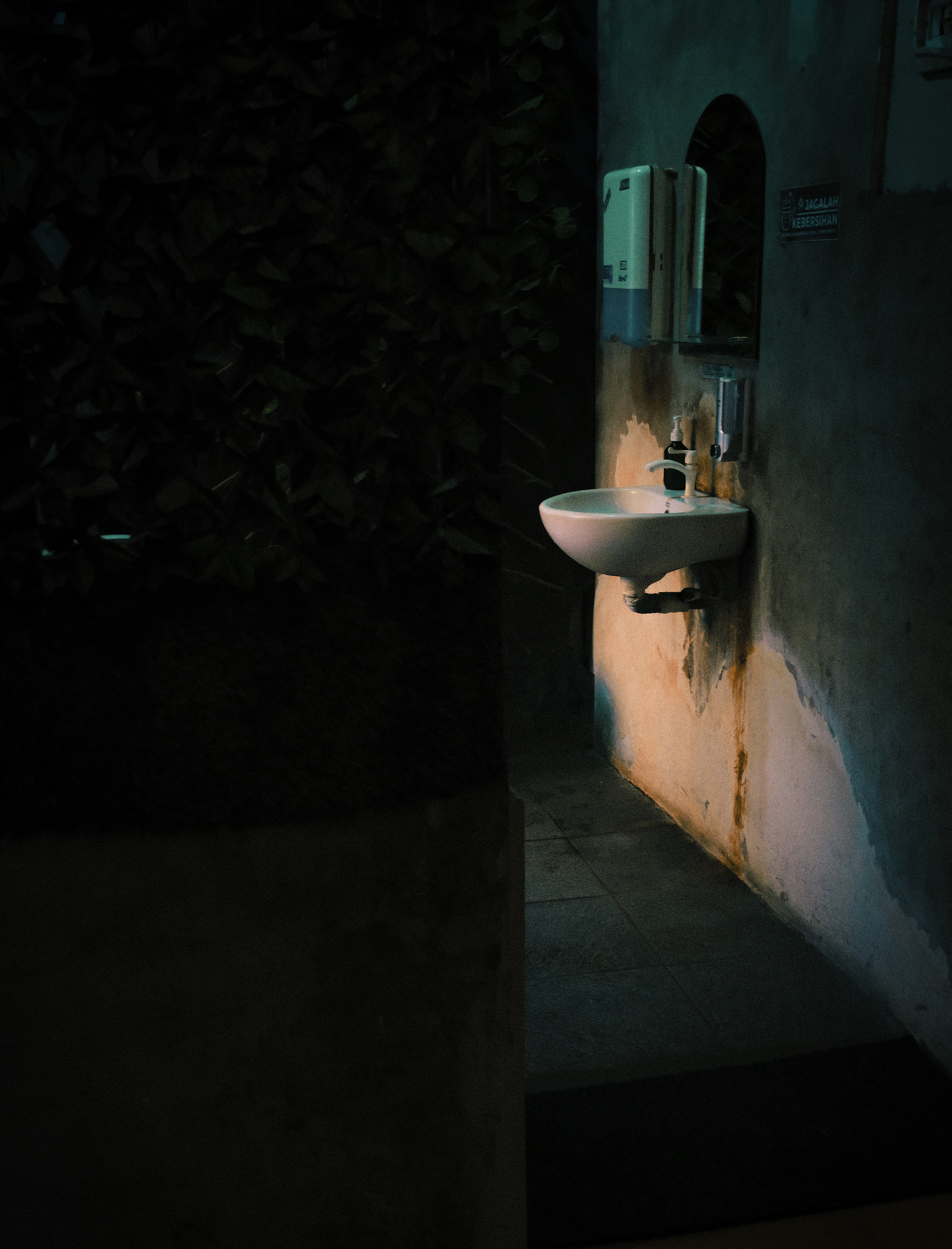 Forgotten Sink in Neon Corridor