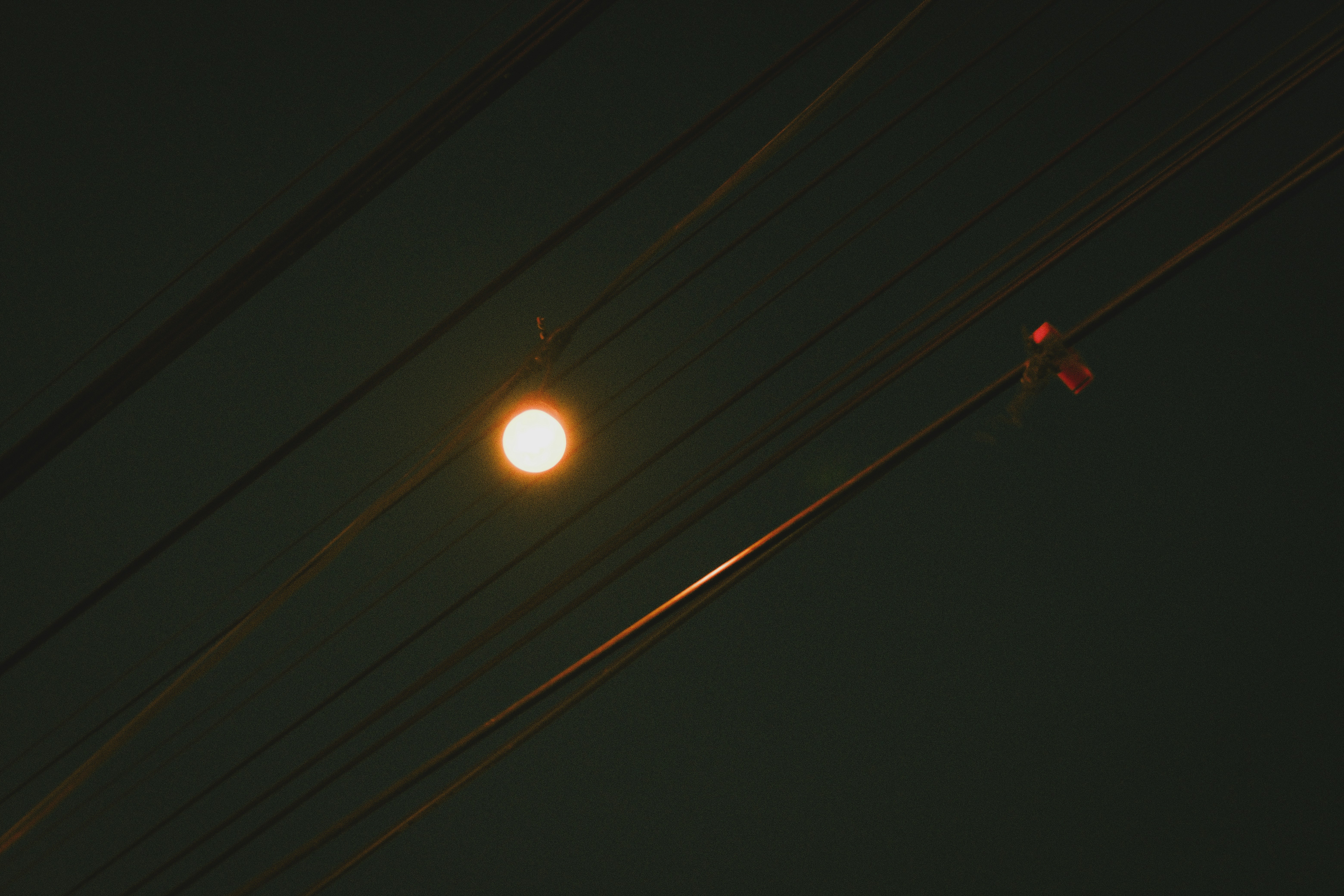 Night Wire: A Luminous Street Lamp Skewered by Power Lines