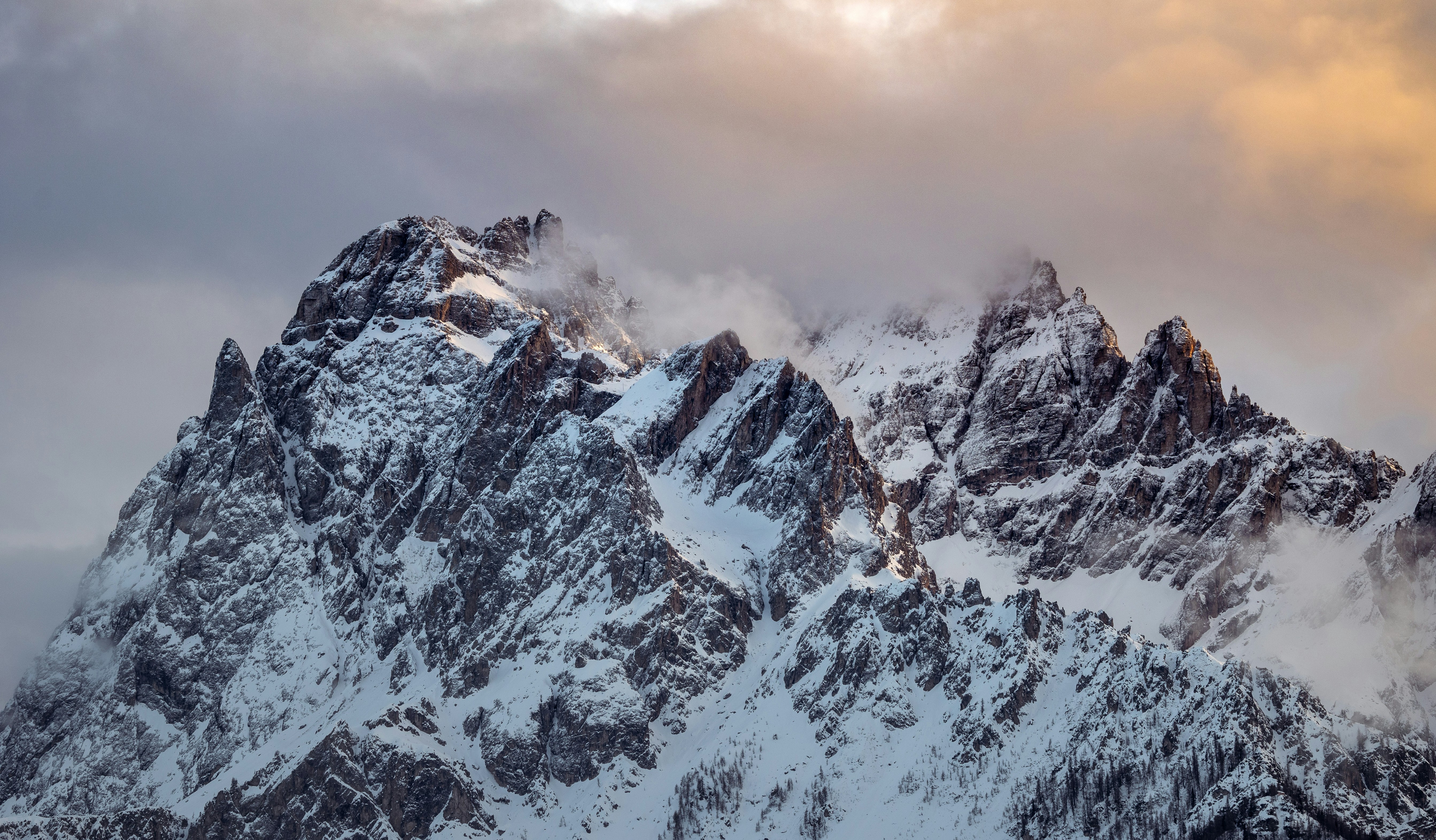 Twilight Summit: Snow-Crowned Peaks Emerging from Mist