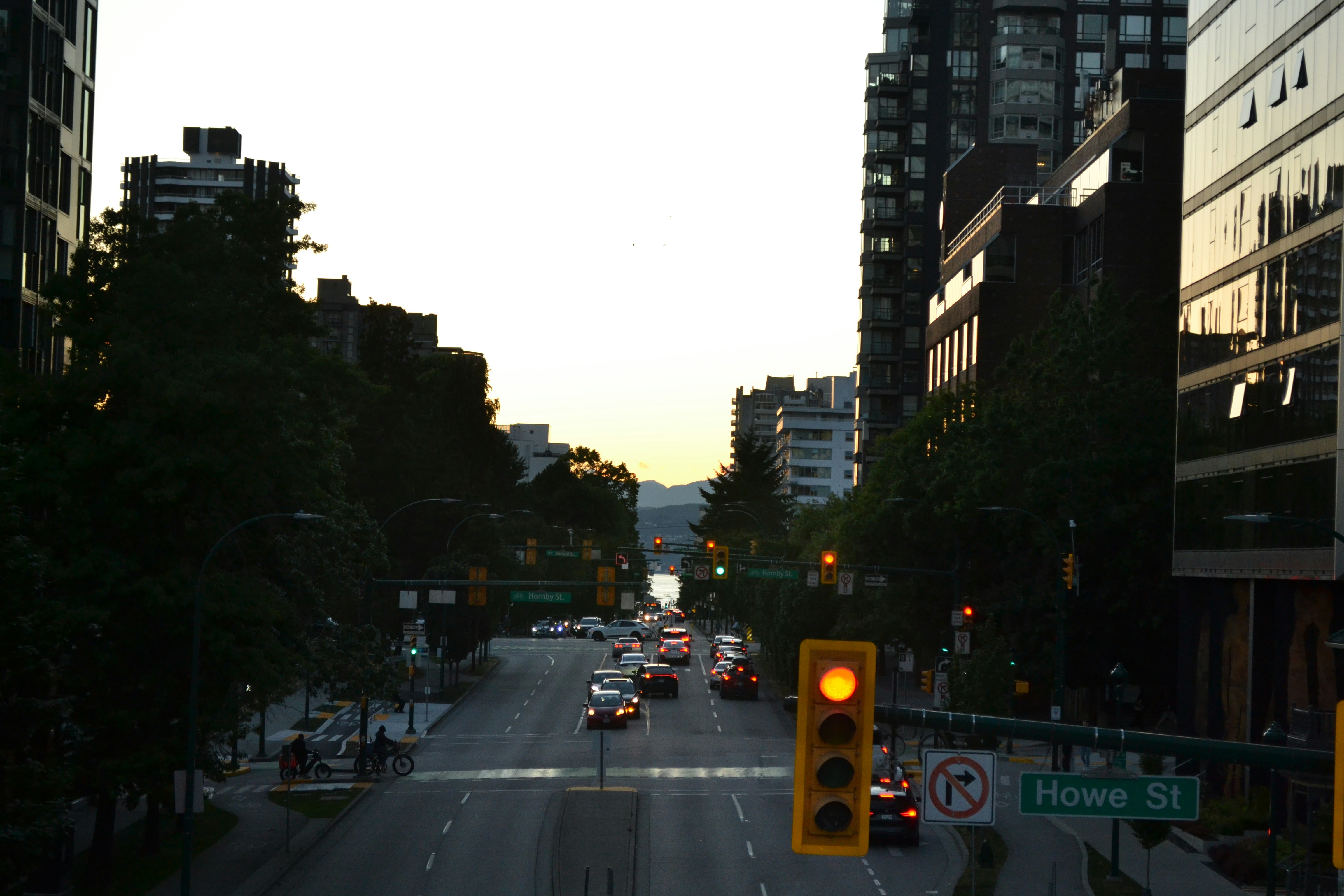City Street at Sunset: Cars, Traffic Light, and High-Raced Towers