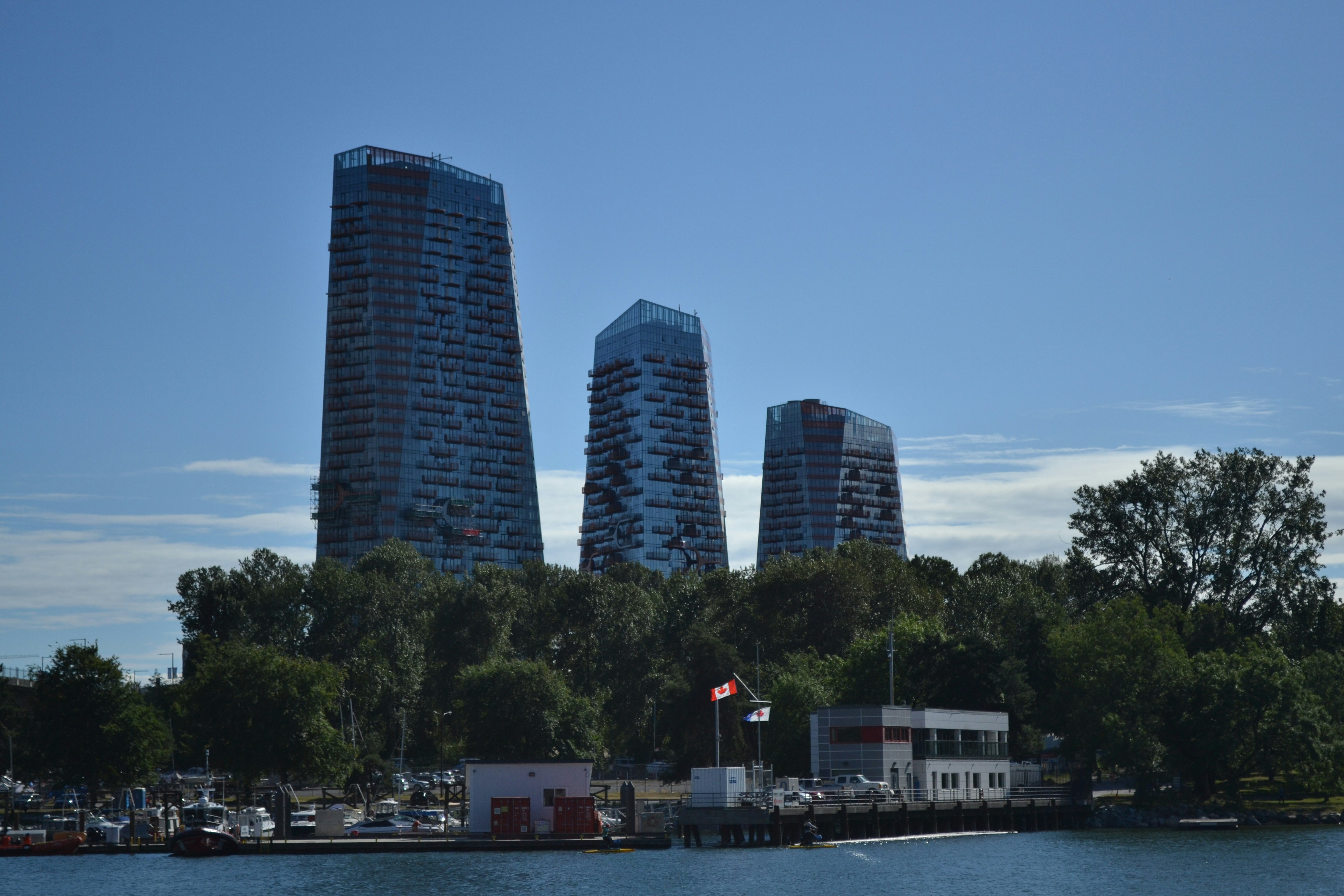 Three Modern Towers Rising Over a Waterfront Park