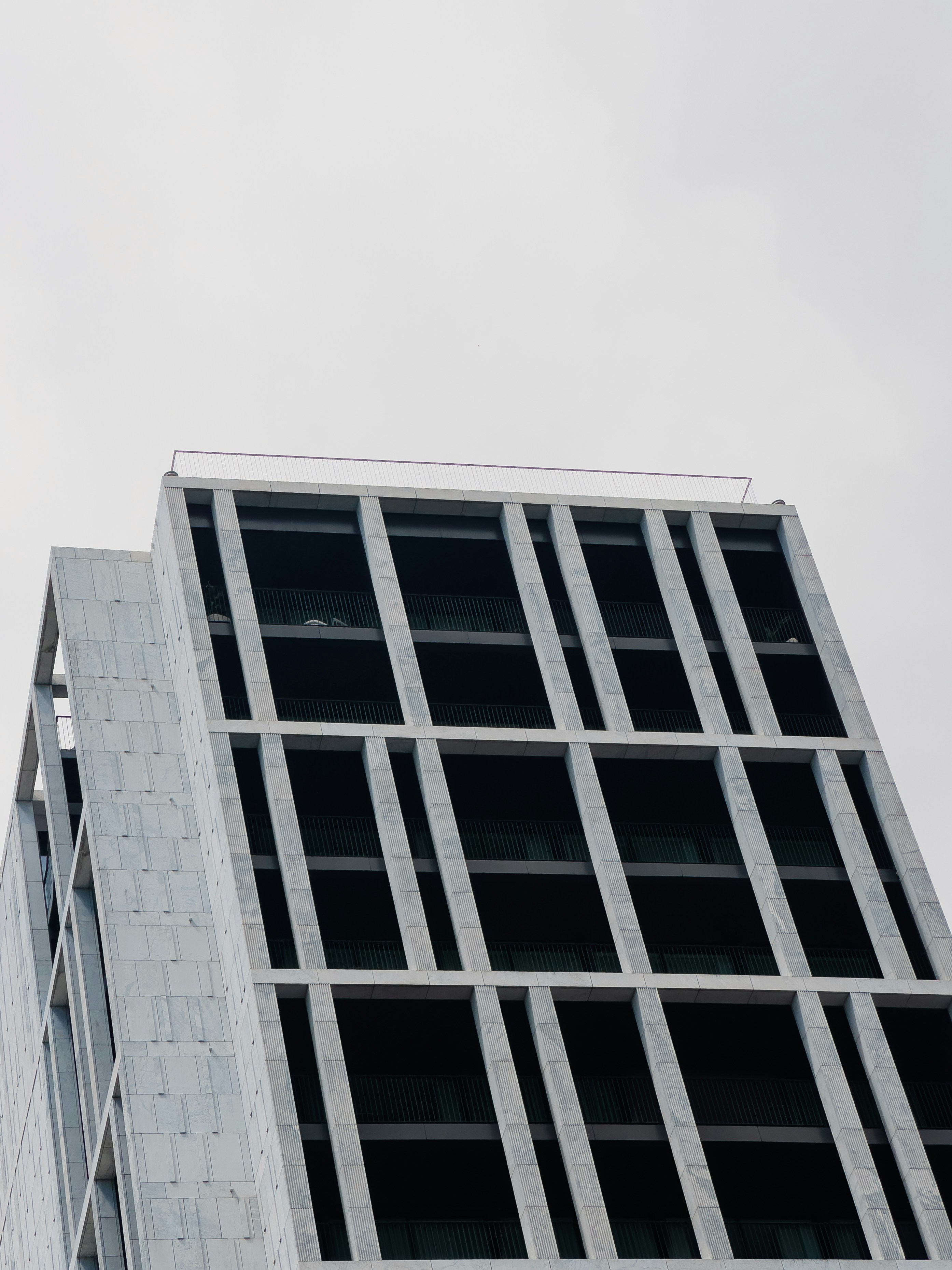 Concrete Grid: A Harsh Angled Facade Reaches Toward the Sky