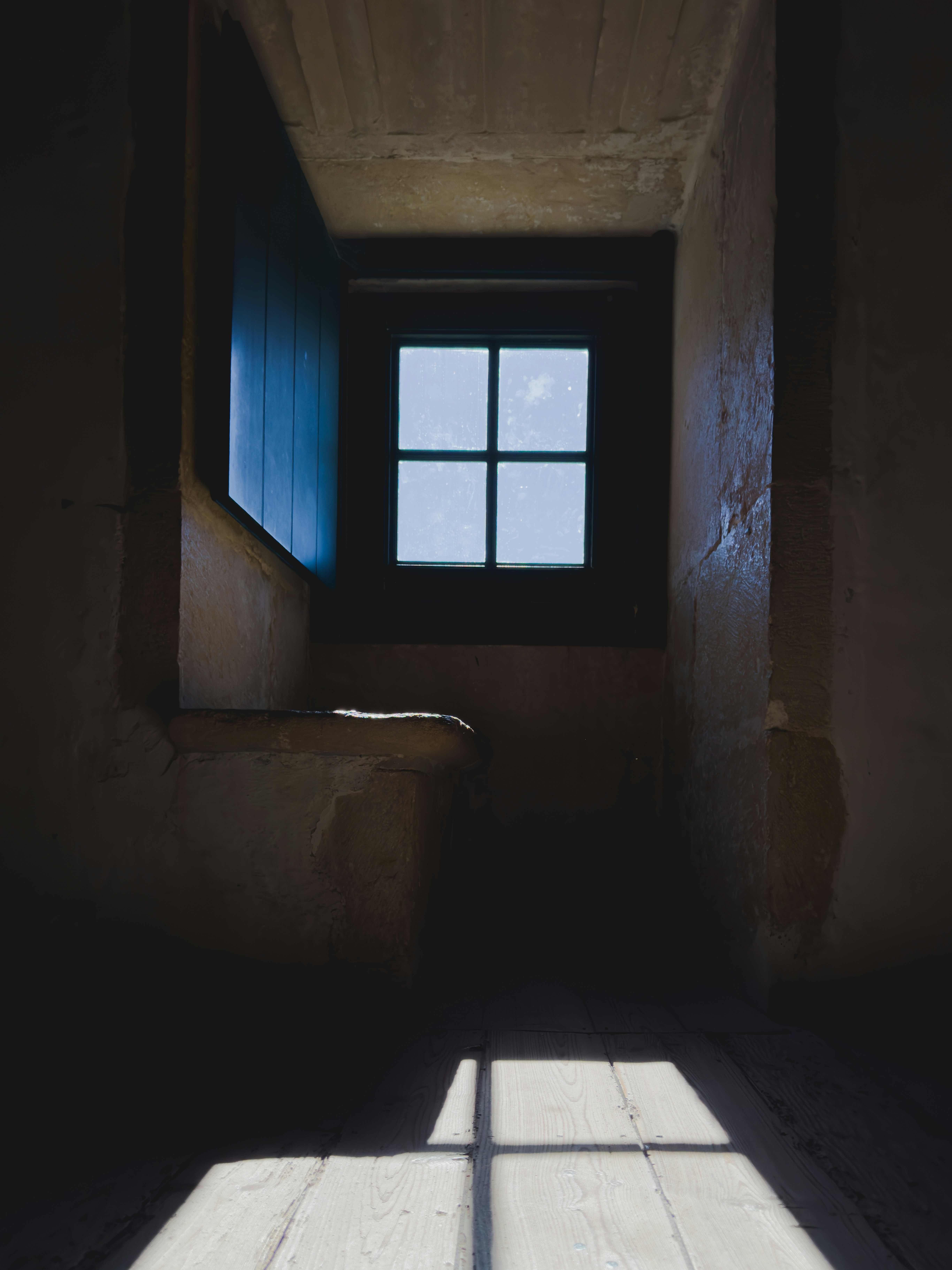 Blue Window in a Narrow Stairwell