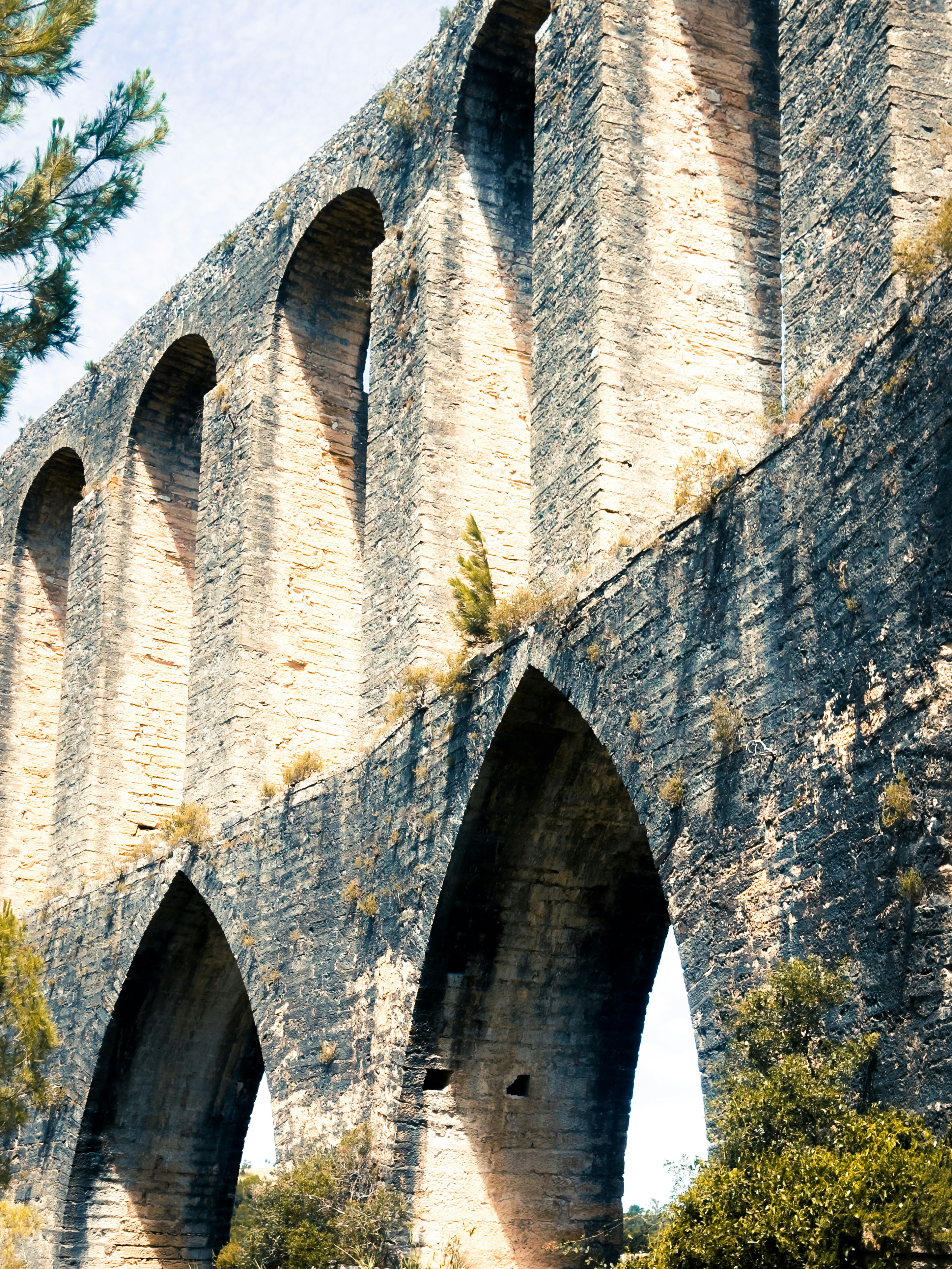 Ancient Viaduct Arches: Sunlit Stone Crowns