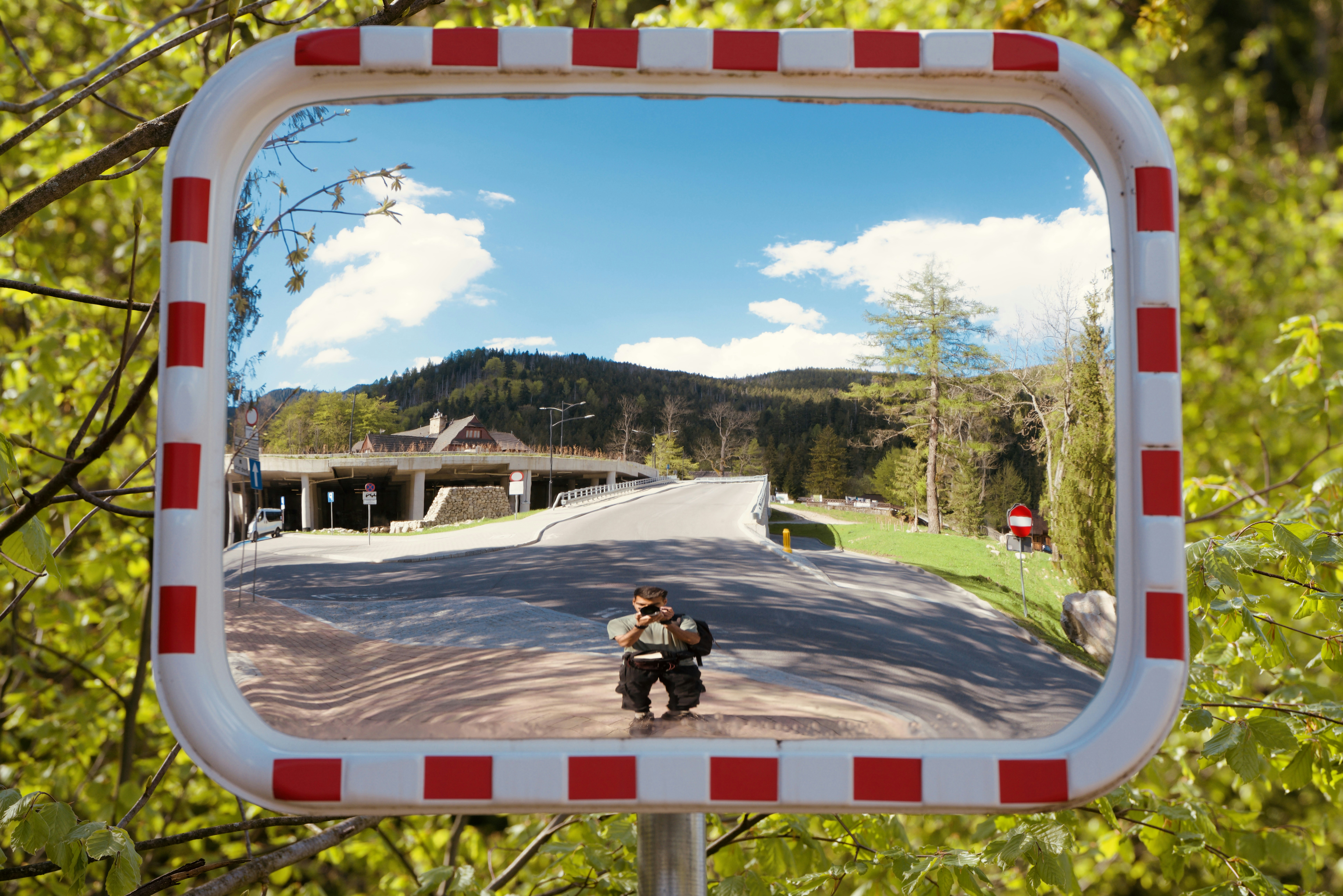 Mirrored Gate: A Canyon Road Framed by Red-White Guard Rail