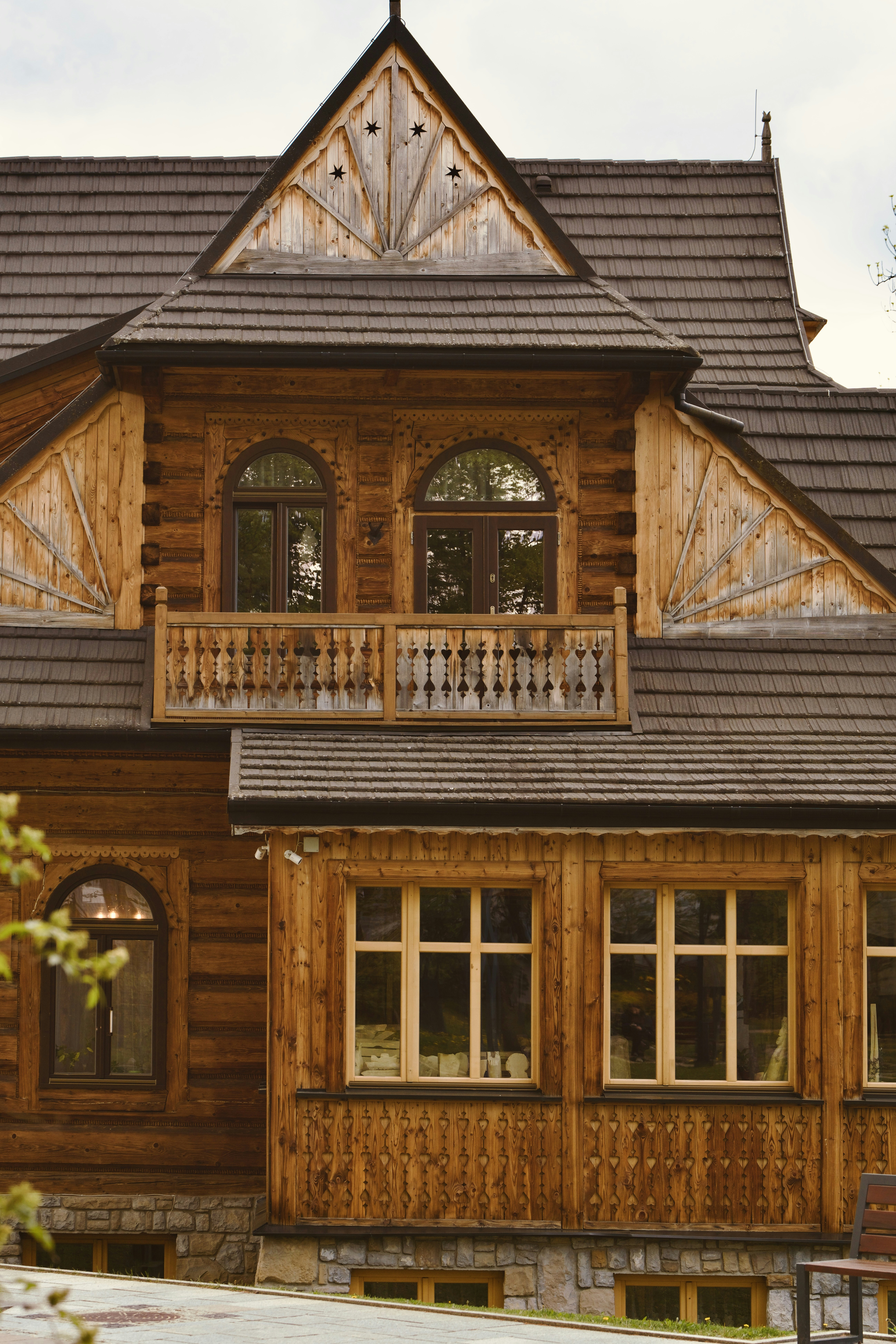 Rustic Chalet Facade: Carved Windows and Sloped Roofs