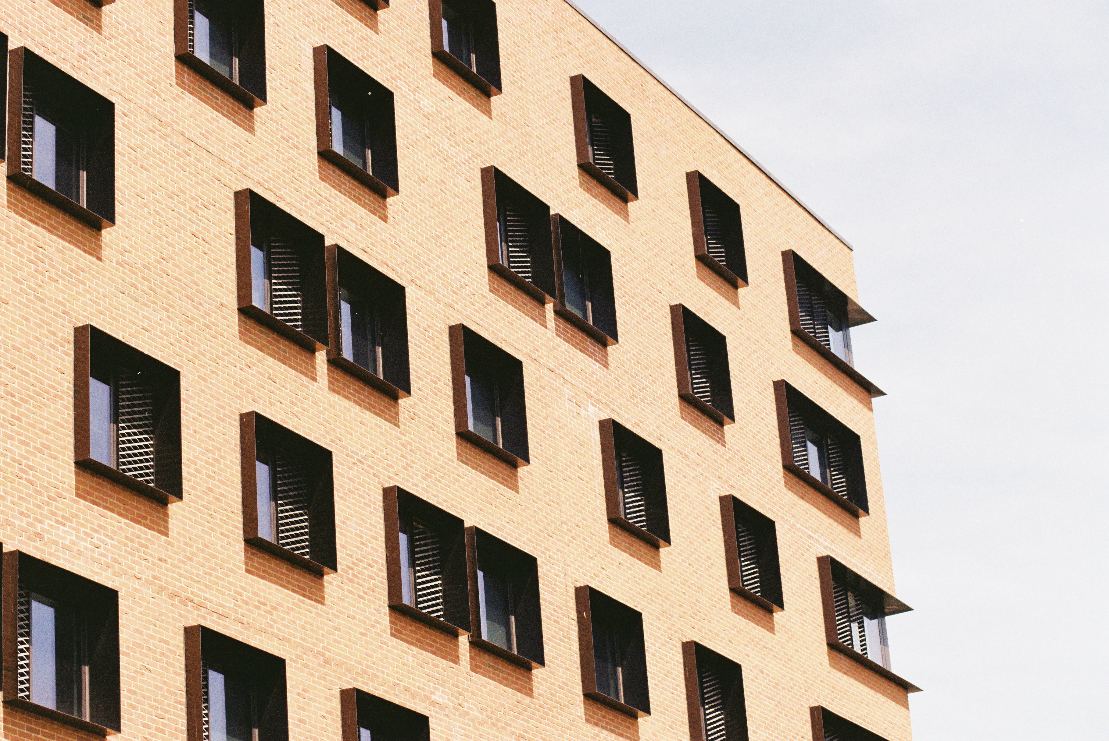 Brick Facade Dots: A Grid of Windows Ascends