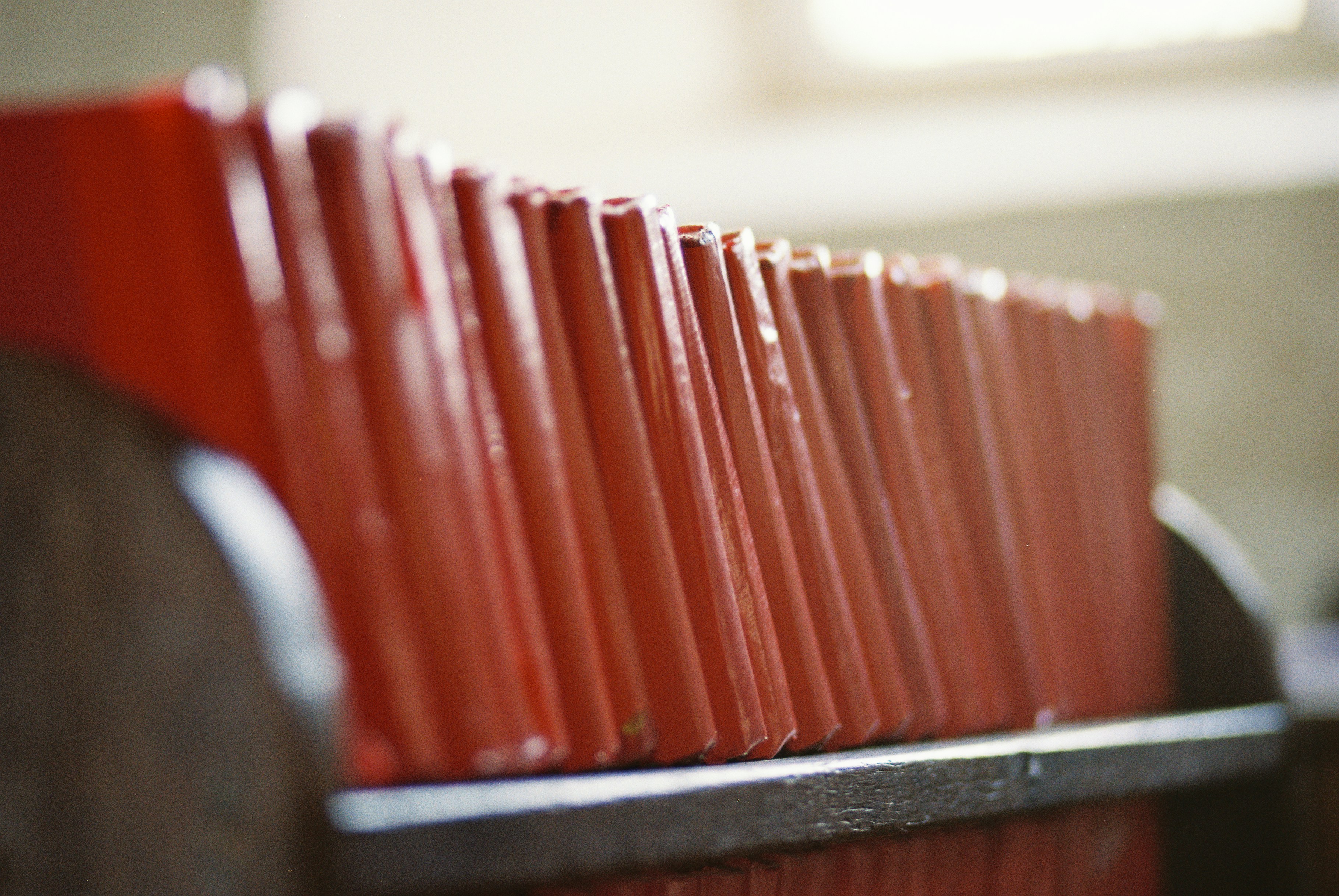 Crimson Rails: A Row of Painted Wake in Soft Light