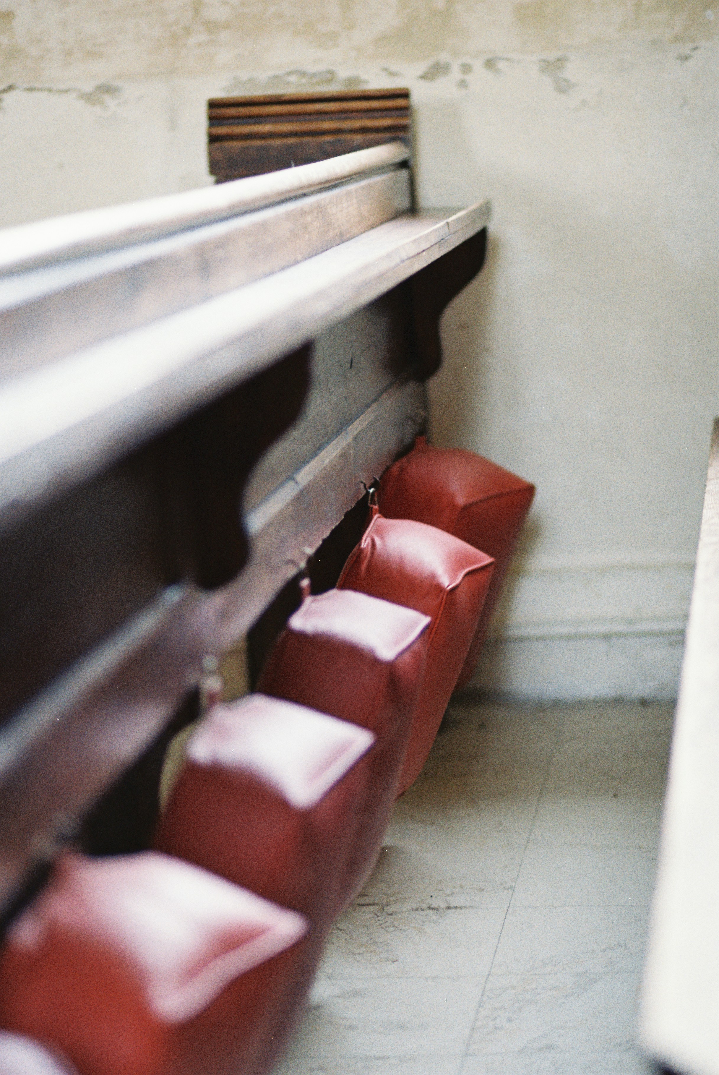 Red Cushioned Seats Along a Quiet School Corridor Bench