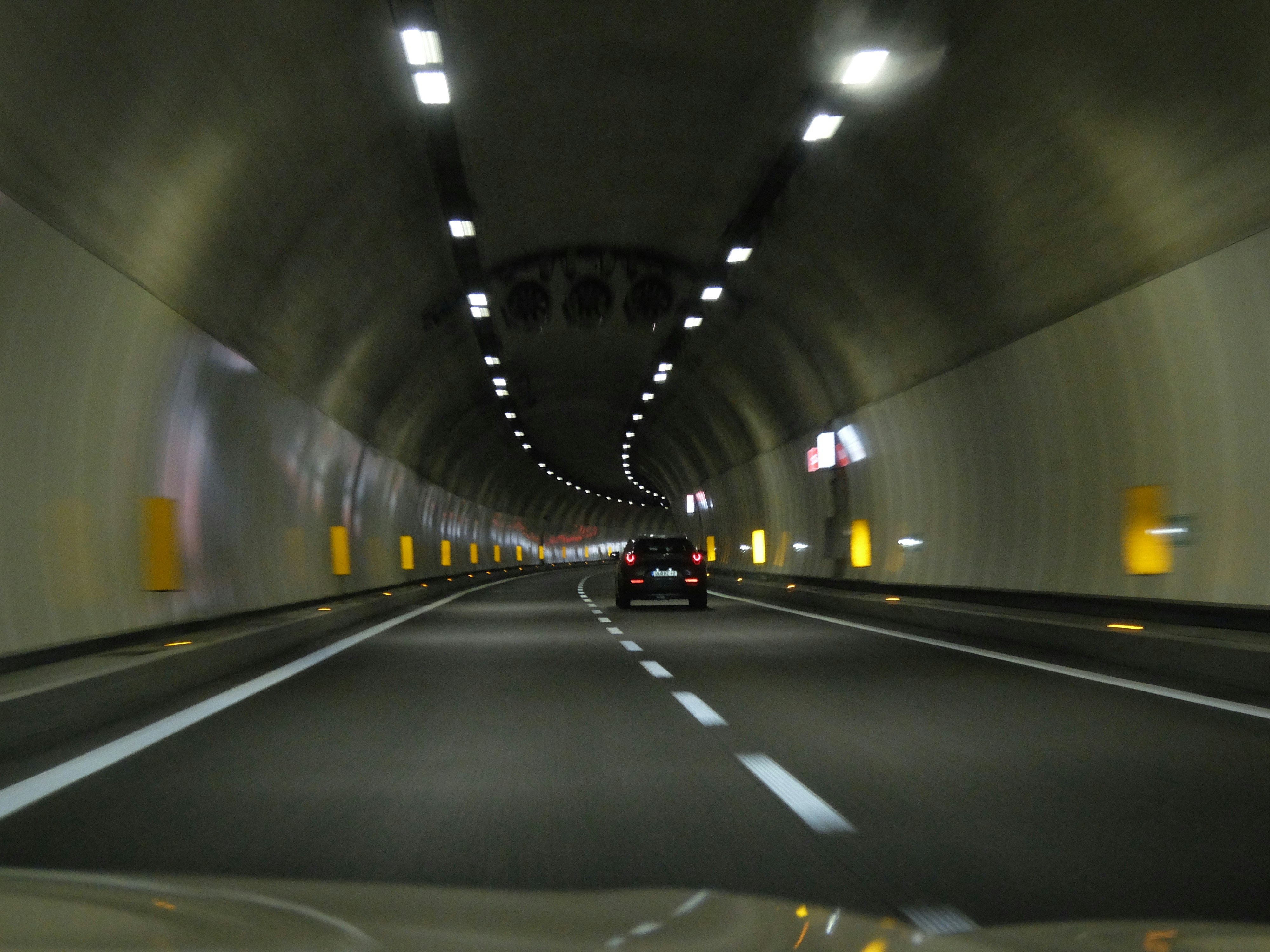 Mid-Tunnel Ascent: Car Reaching the Light at the End of the Subway-Like Bow