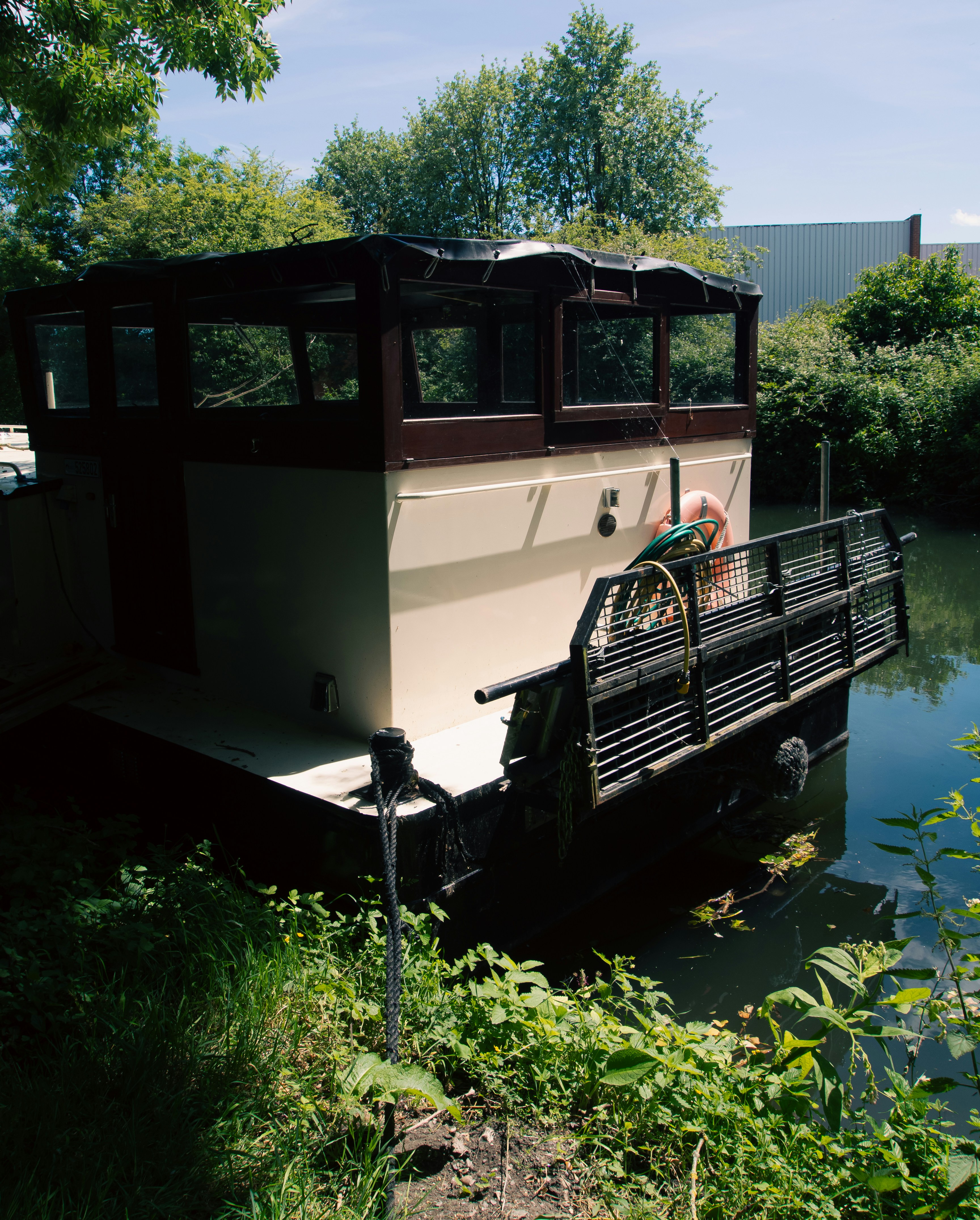 Sunlit Houseboat on a Quiet Canal