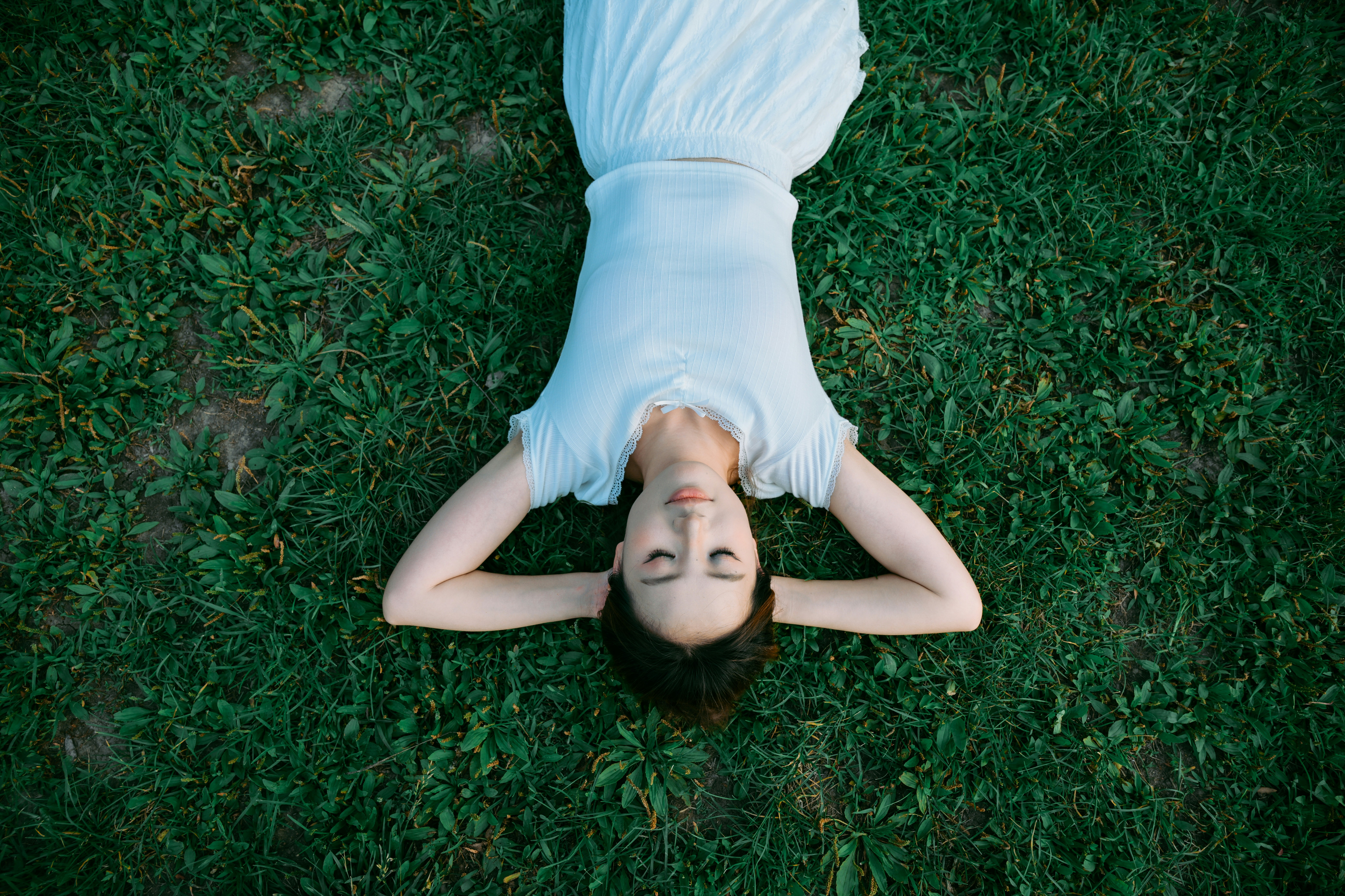 Lying in Quiet: A Serene Portrait of Stillness on Grass