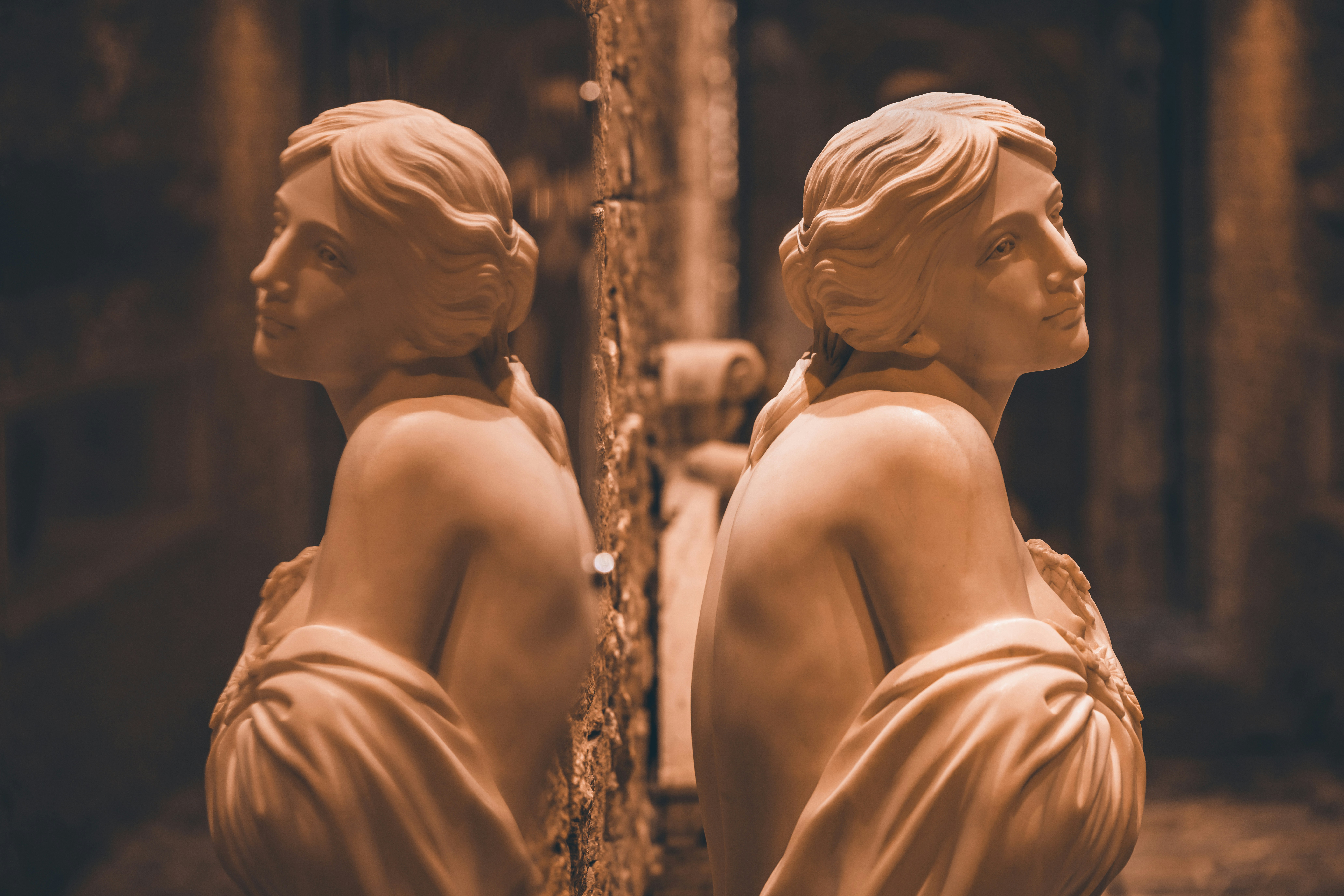 Twin Statues in Amber Light