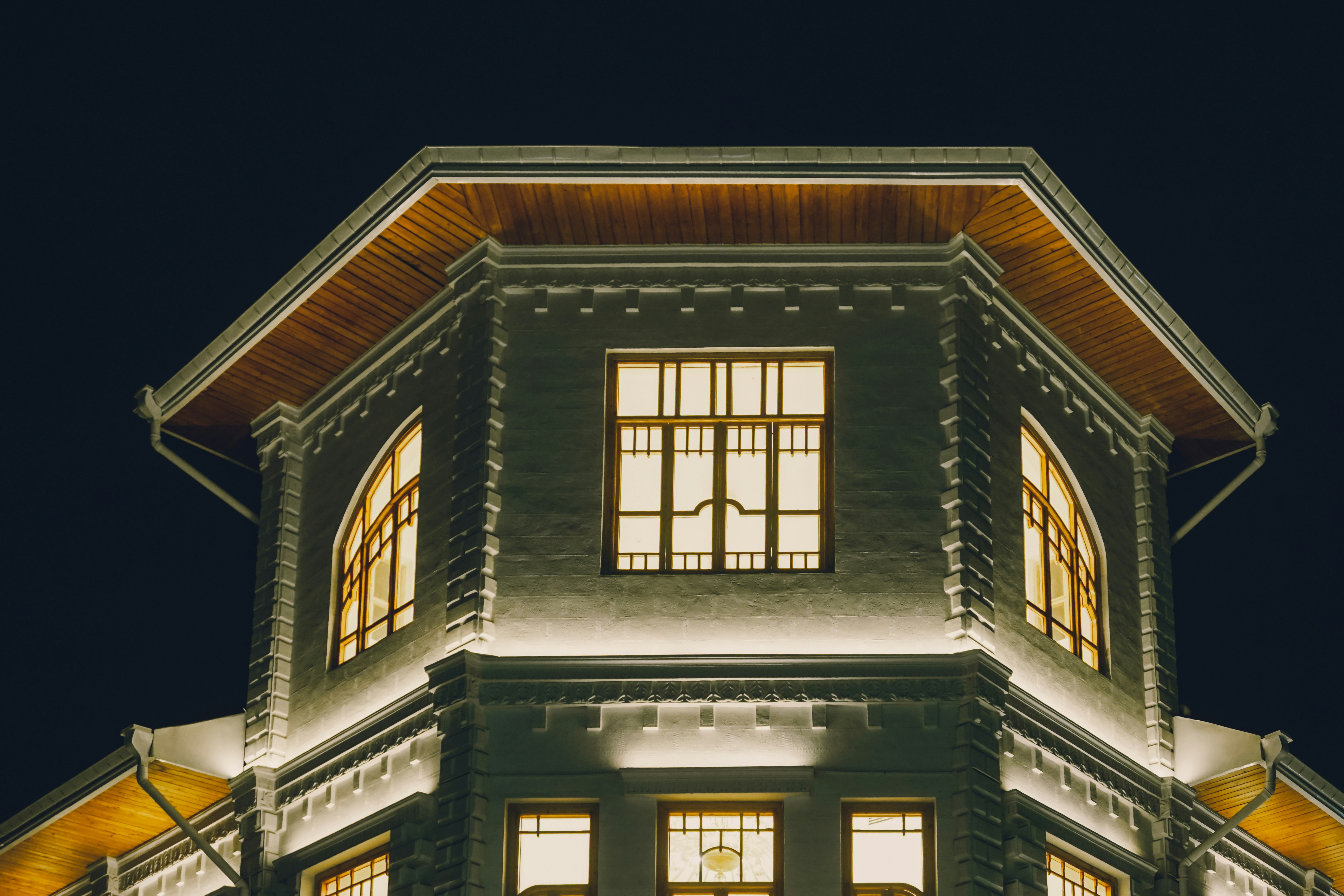 Lit Cornerstone: A Nighttime Facade with Warm Windows