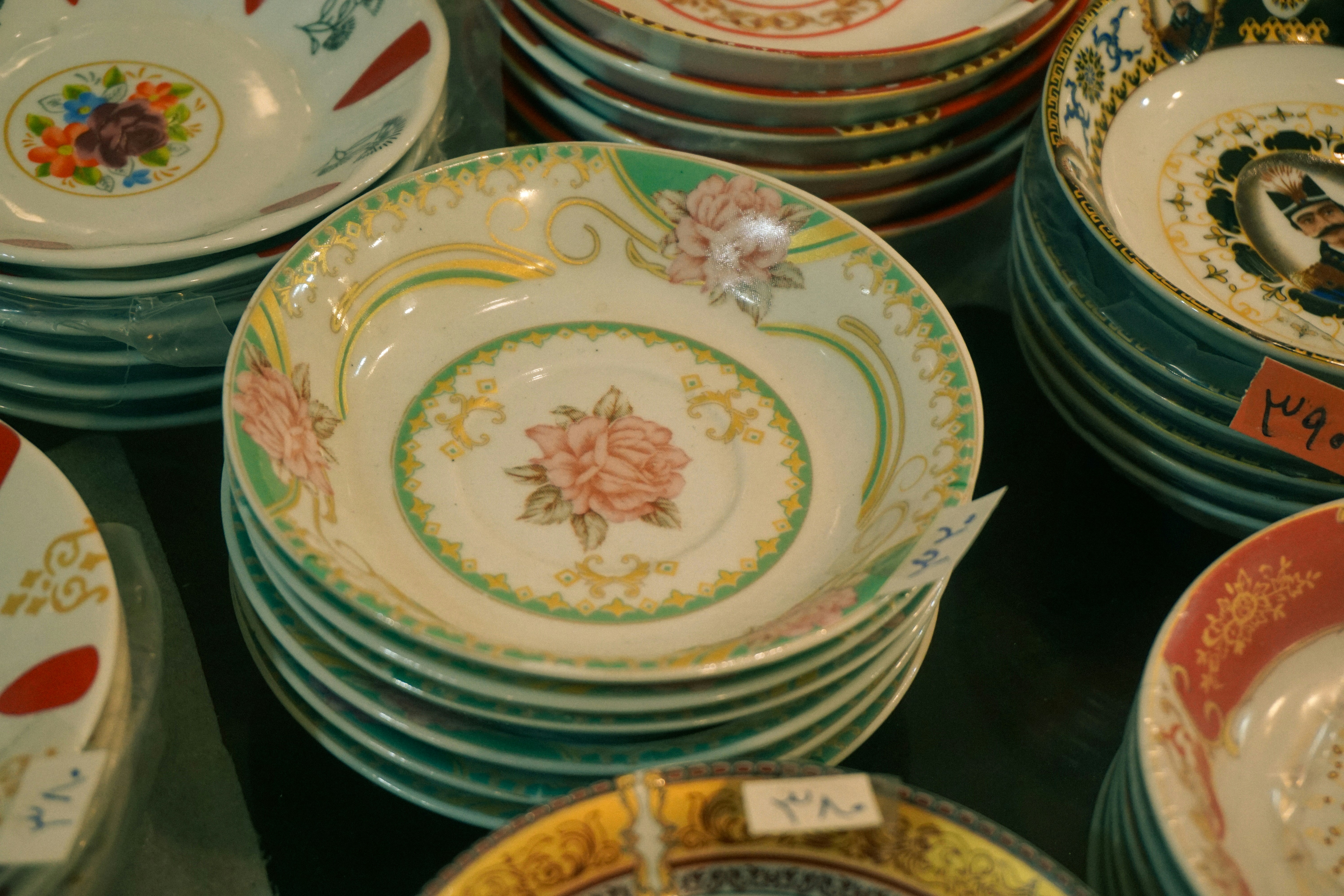 Floral Stack: Delicate Porcelain Plates in a Piled Display