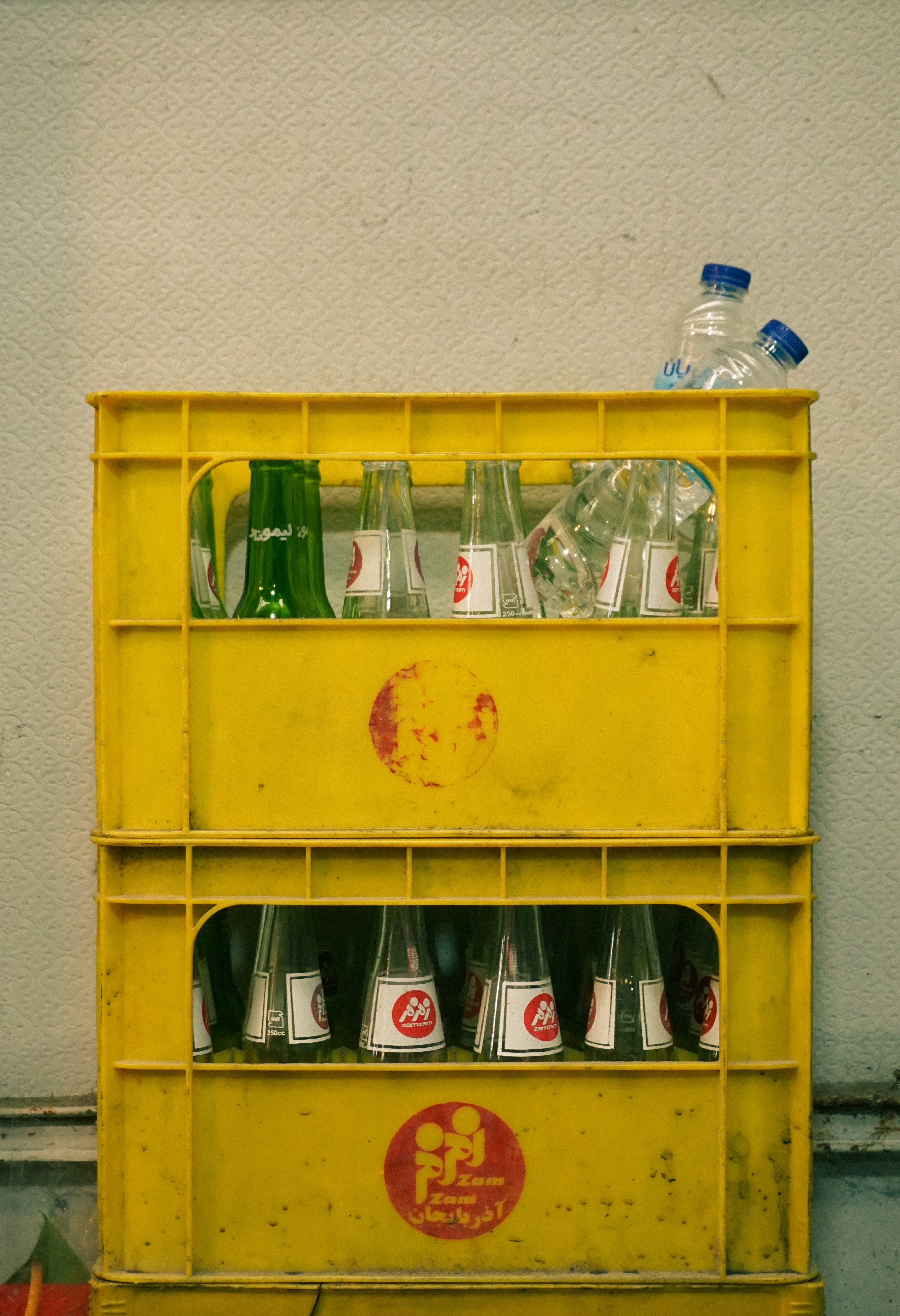 Yellow Crate of Bottles: A Quiet Stack in the Corner