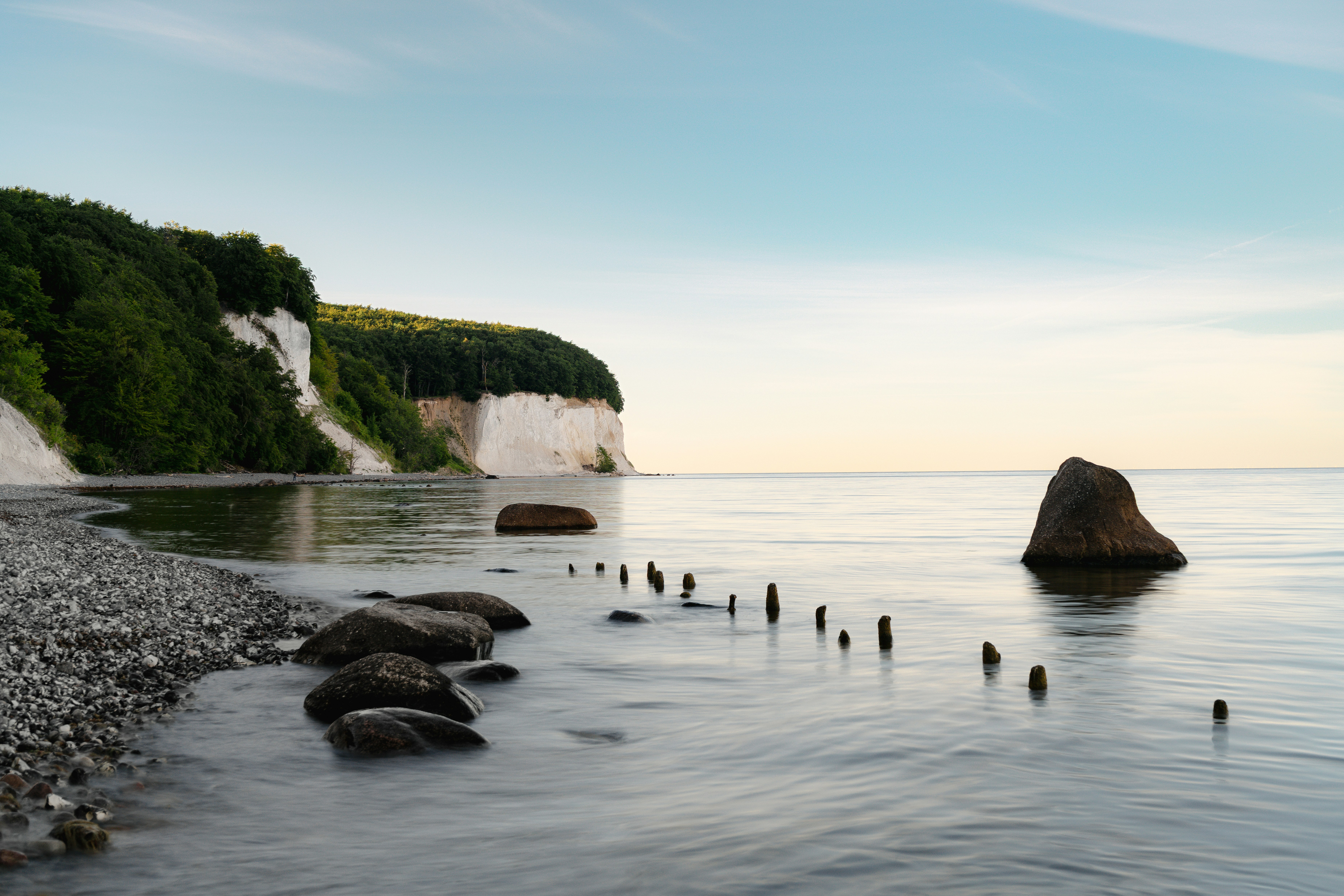Quiet Sea Staircase: Stones, Posts, and Cliffline at Dusk