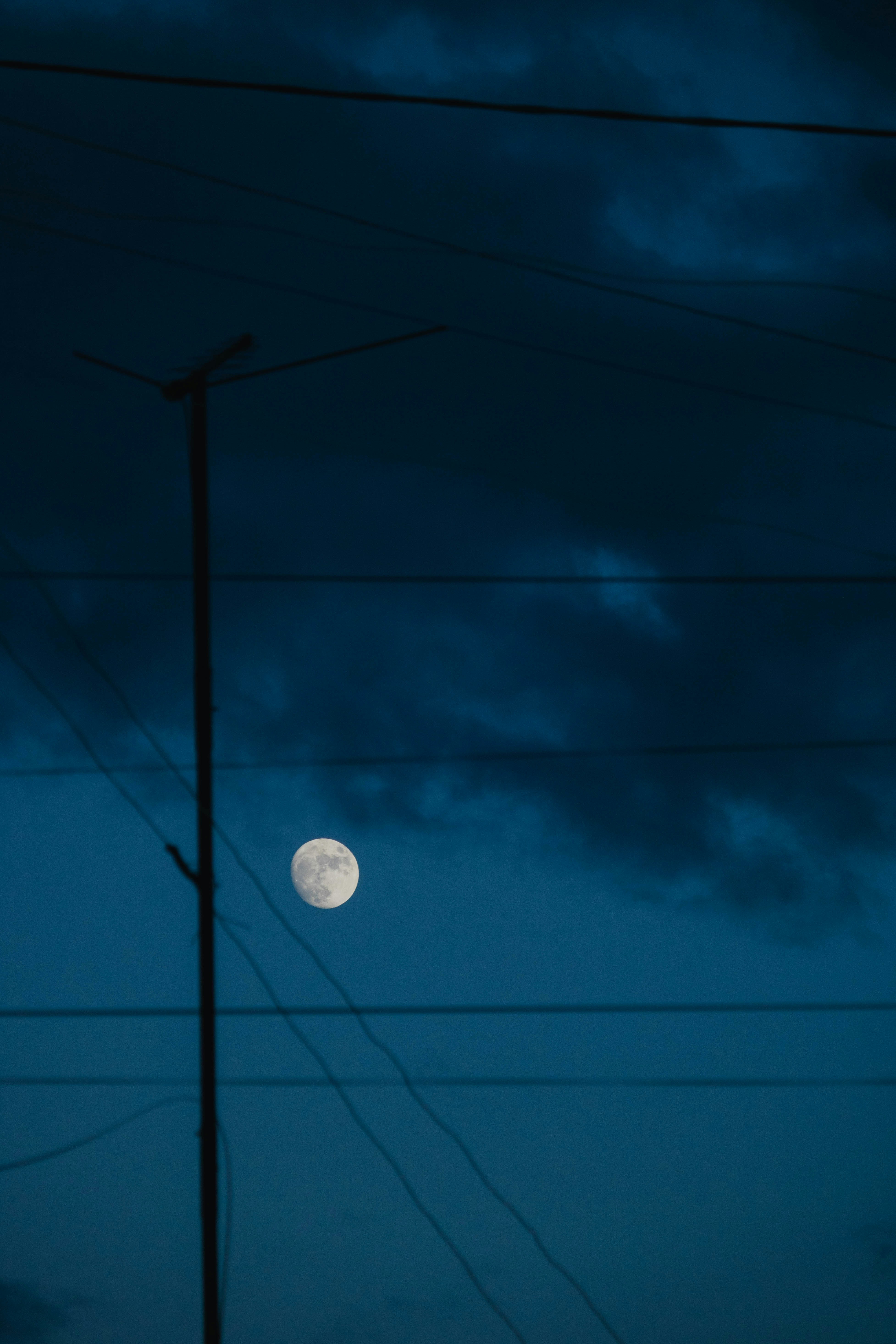 Moonlit Utility Lines over a Midnight Sky