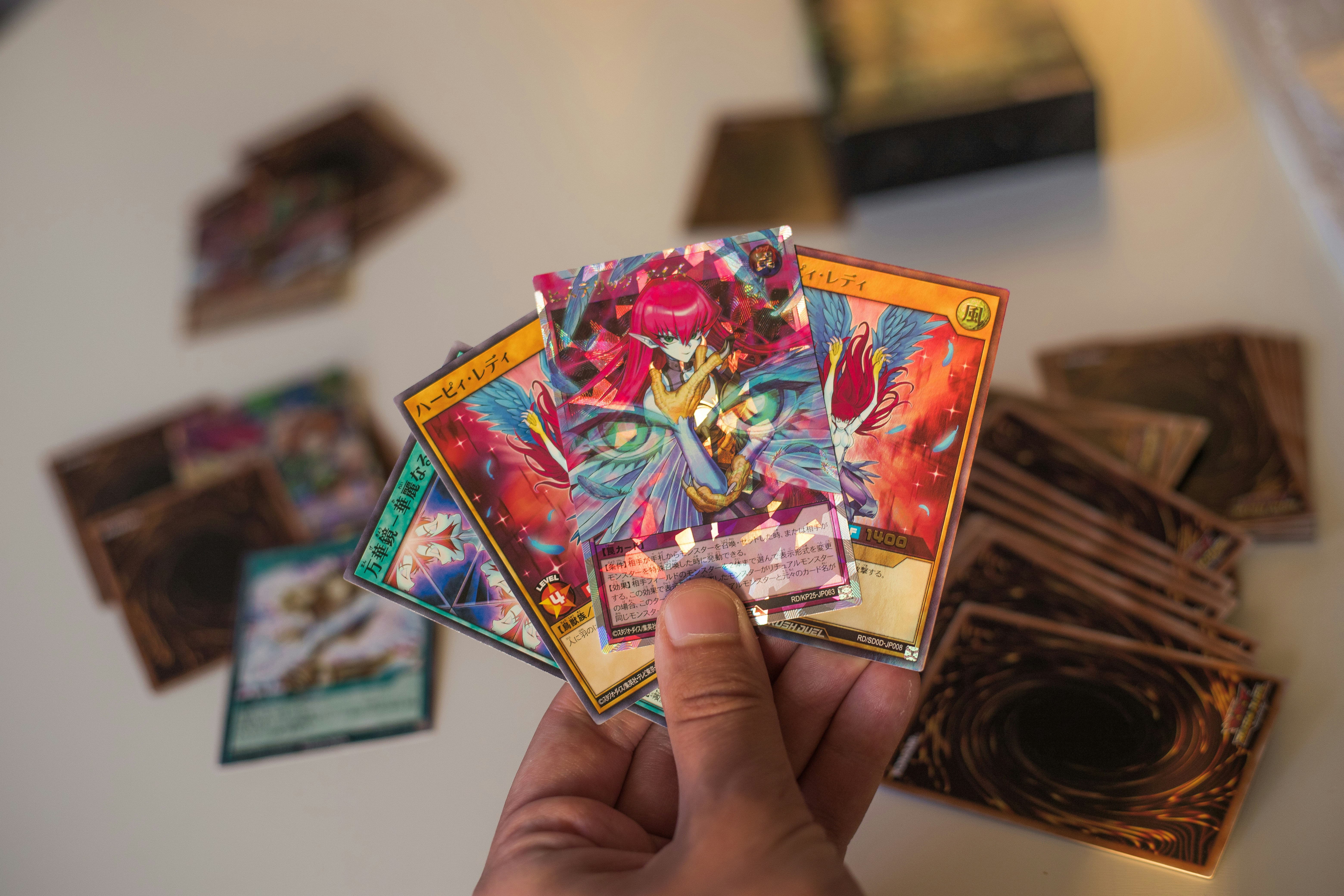 Handful of Neon-Backed Yu-Gi-Oh Cards in Focus